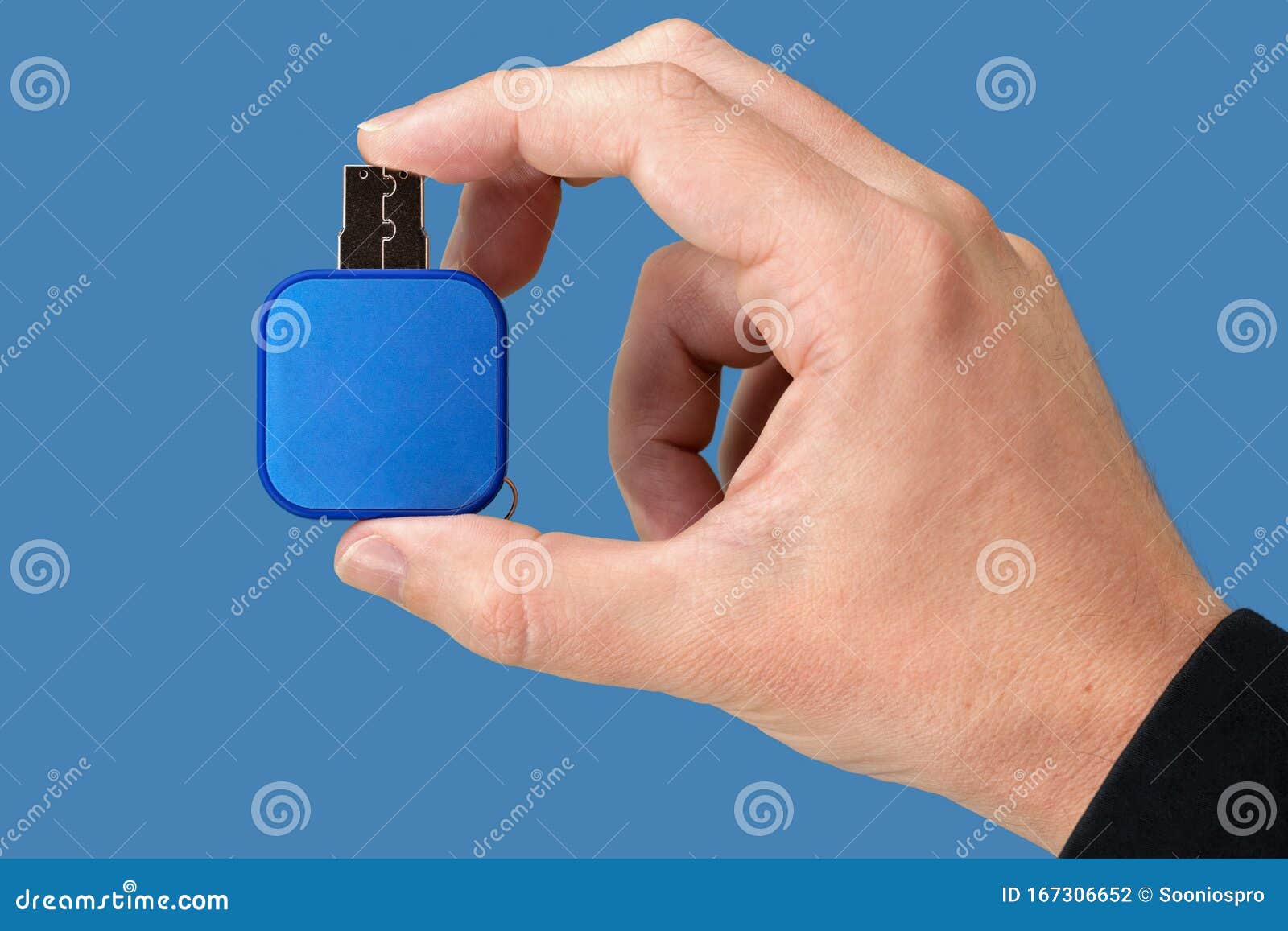 Blue Flash Drive on Hand with Isolated Blue Background Stock Photo ...