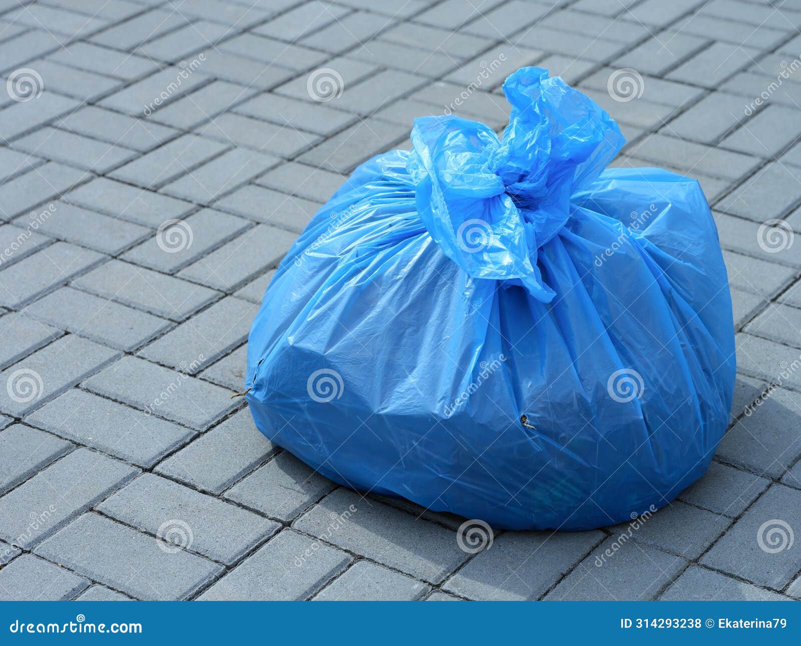 Blue Garbage Bag Full of Trash Standing on the Gray Stone Paving Slabs ...