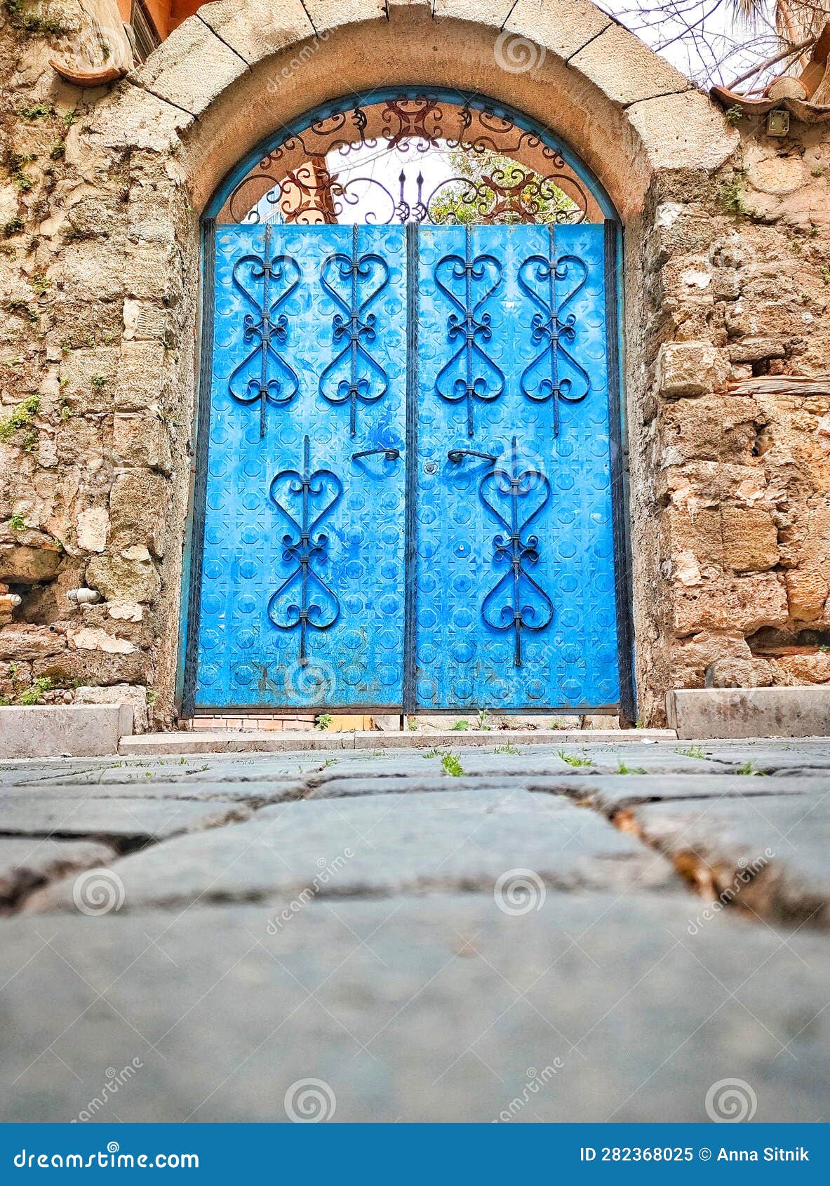 Blue Gate with Patterned Forging on Background of Facade of Old Masonry ...