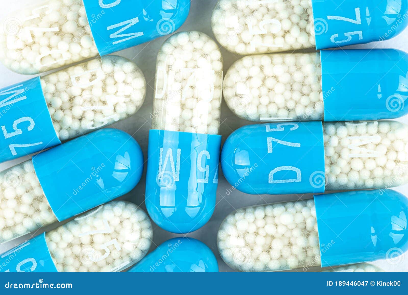 Blue Gelatin Capsules with White Granules Inside, on a White Background ...