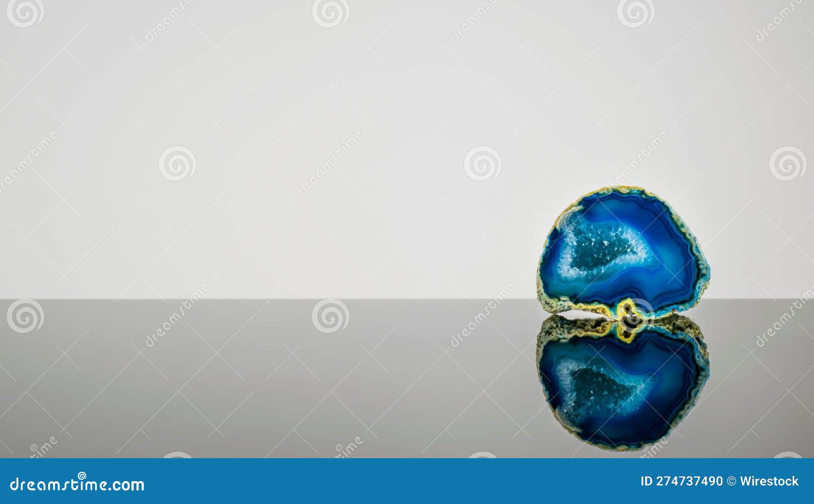 Blue Geode Rock Crystal with Its Reflection Against a Grey Background ...