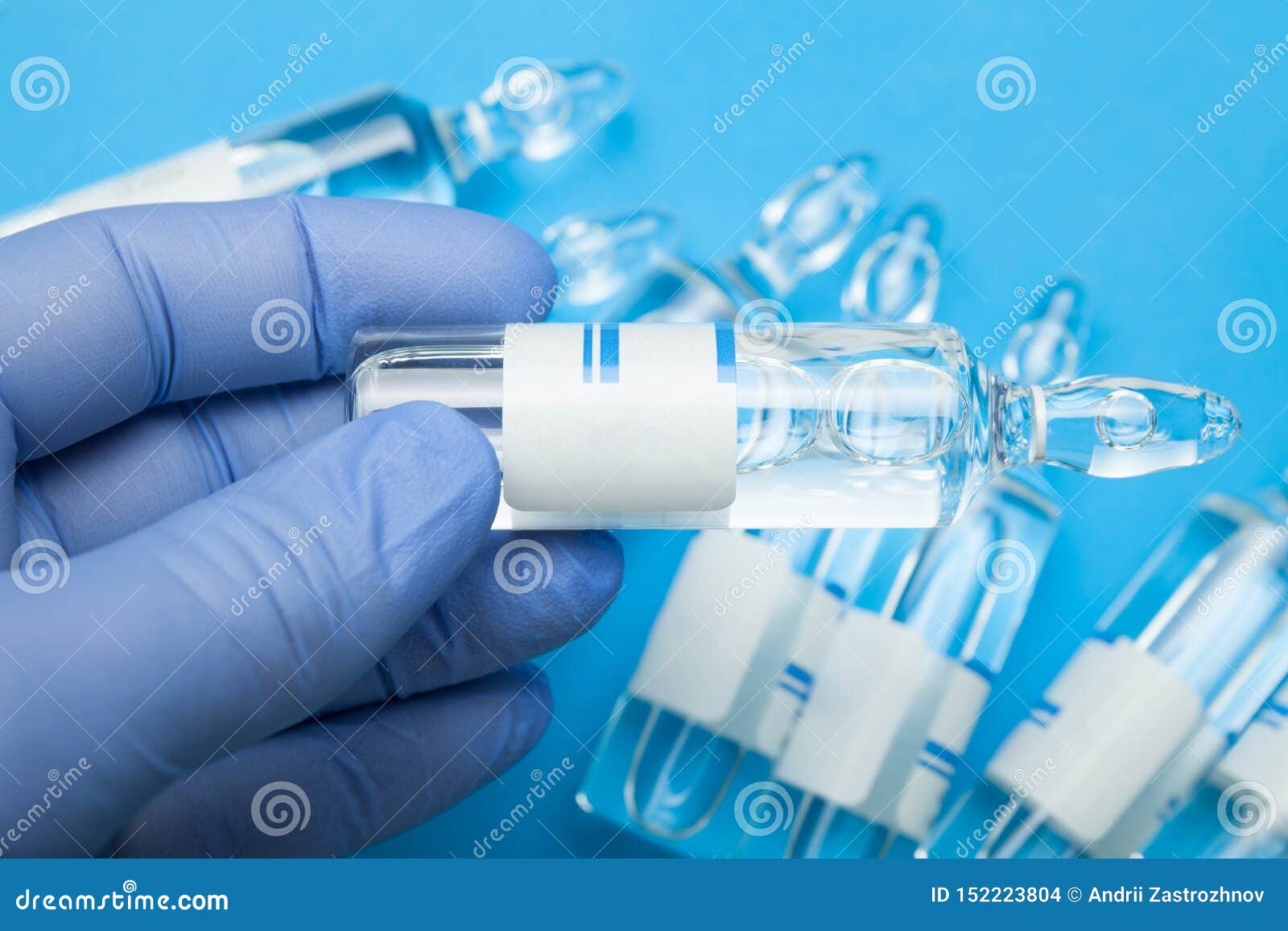 A Blue-gloved Hand Holds an Ampoule with a Clear Liquid Stock Photo ...