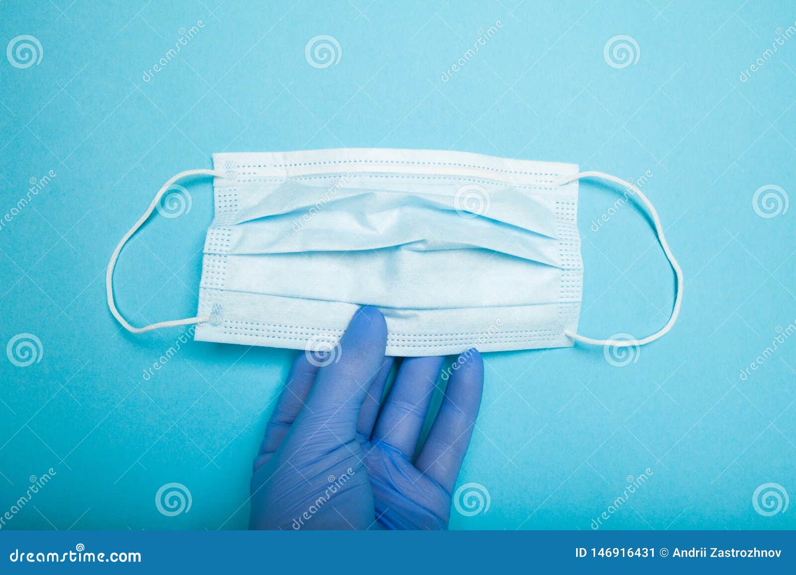 A Blue-gloved Hand Holds a Medical Mask Stock Image - Image of hand ...