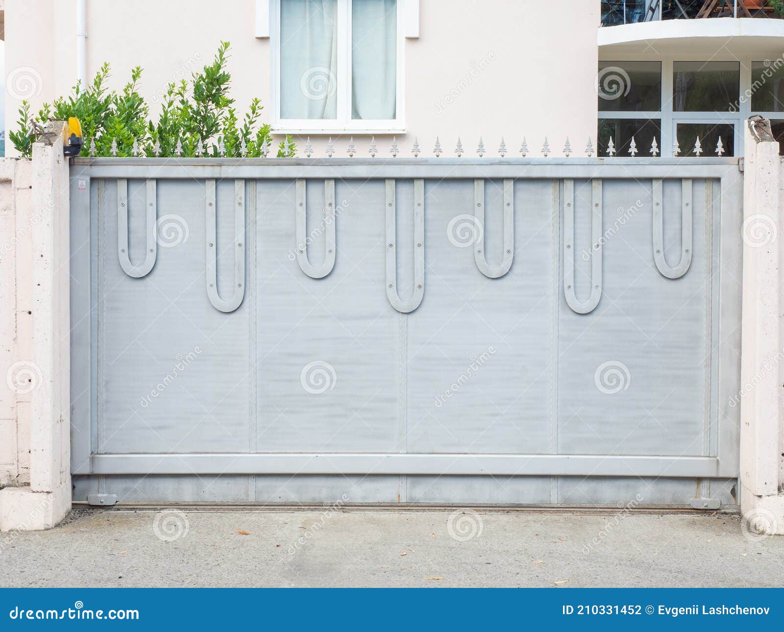 Blue-gray Iron Gates with Sharp Points on Top are Located in Front of a ...