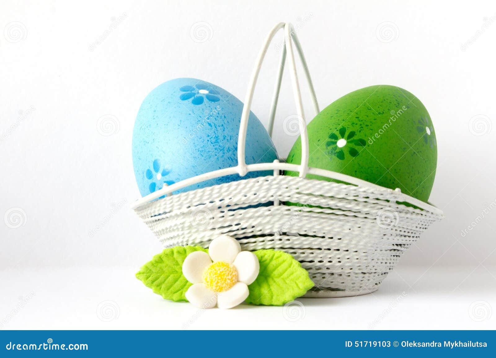 Blue and Green Easter Eggs in a Basket with White Flower Stock Image ...