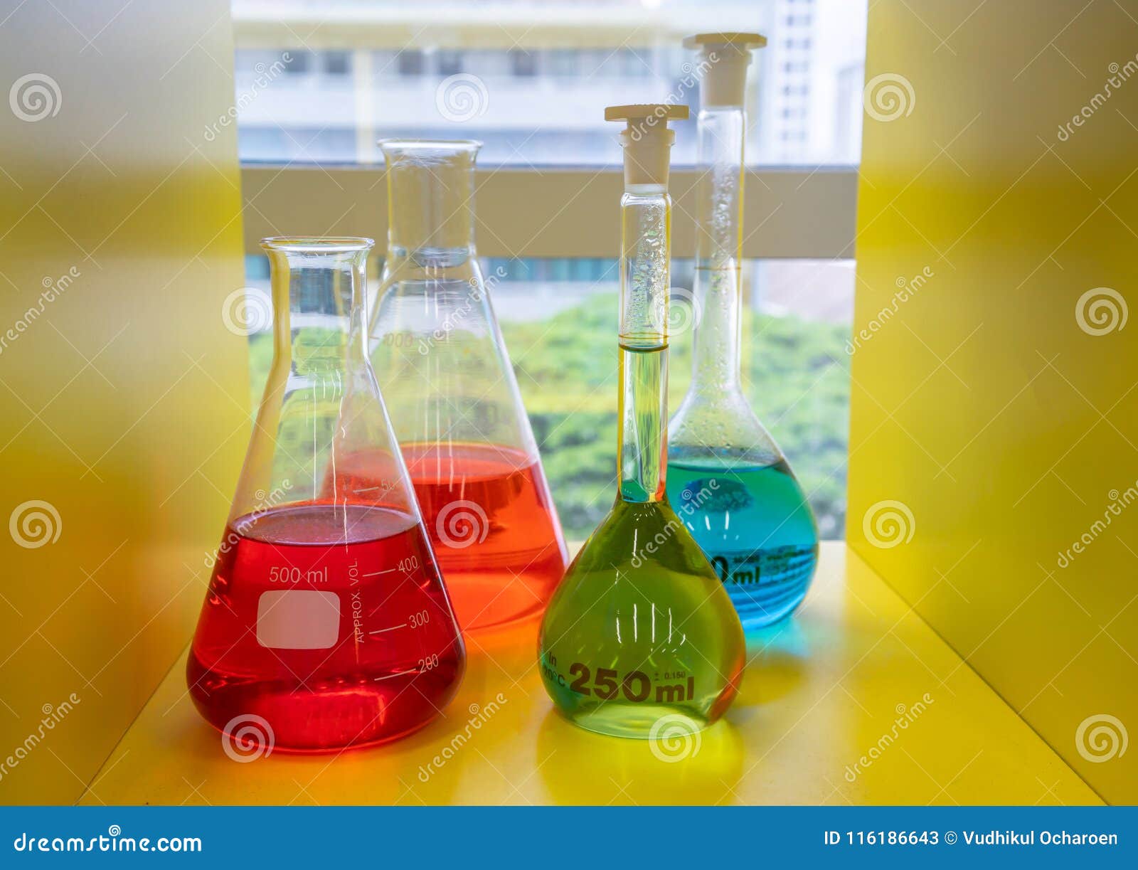Blue and Green Solution in the Glass Beakers on Yellow Shelf Stock ...