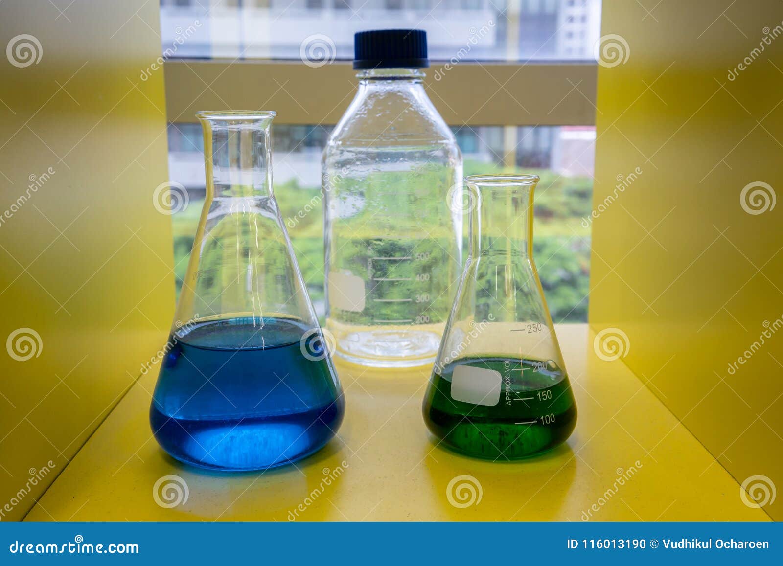 Blue and Green Solution in the Glass Beakers on Yellow Shelf Stock ...