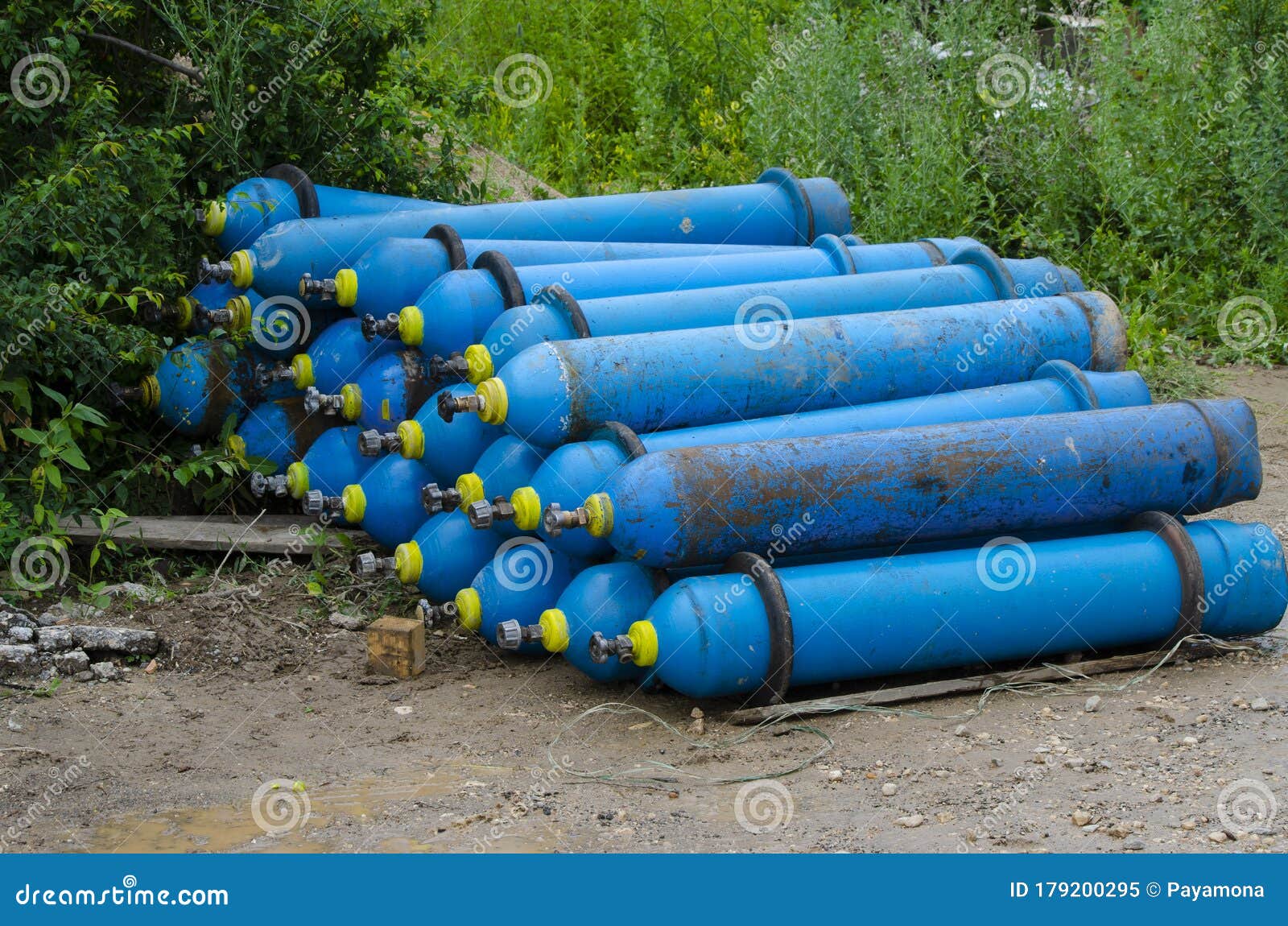 Blue Industrial Oxygen Cylinders on the Ground in the Mud Unsafe ...