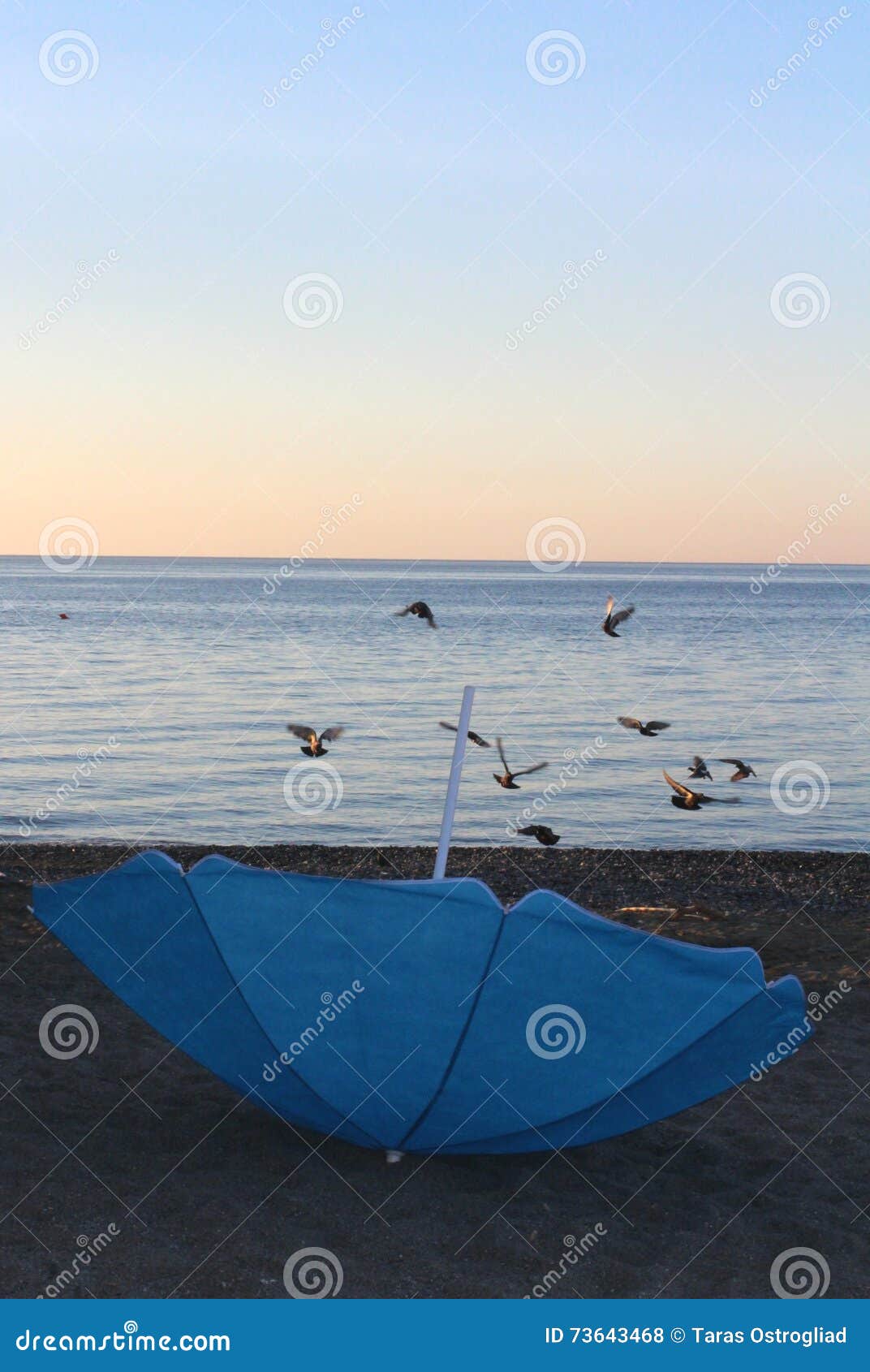Blue Inverted Umbrella on the Beach Stock Photo - Image of lying ...