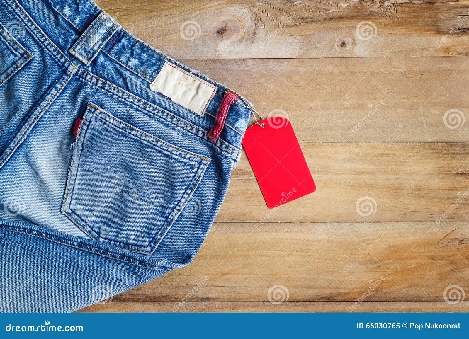 Blue Jeans with Red Blank Tag on Wooden Background Stock Image - Image ...