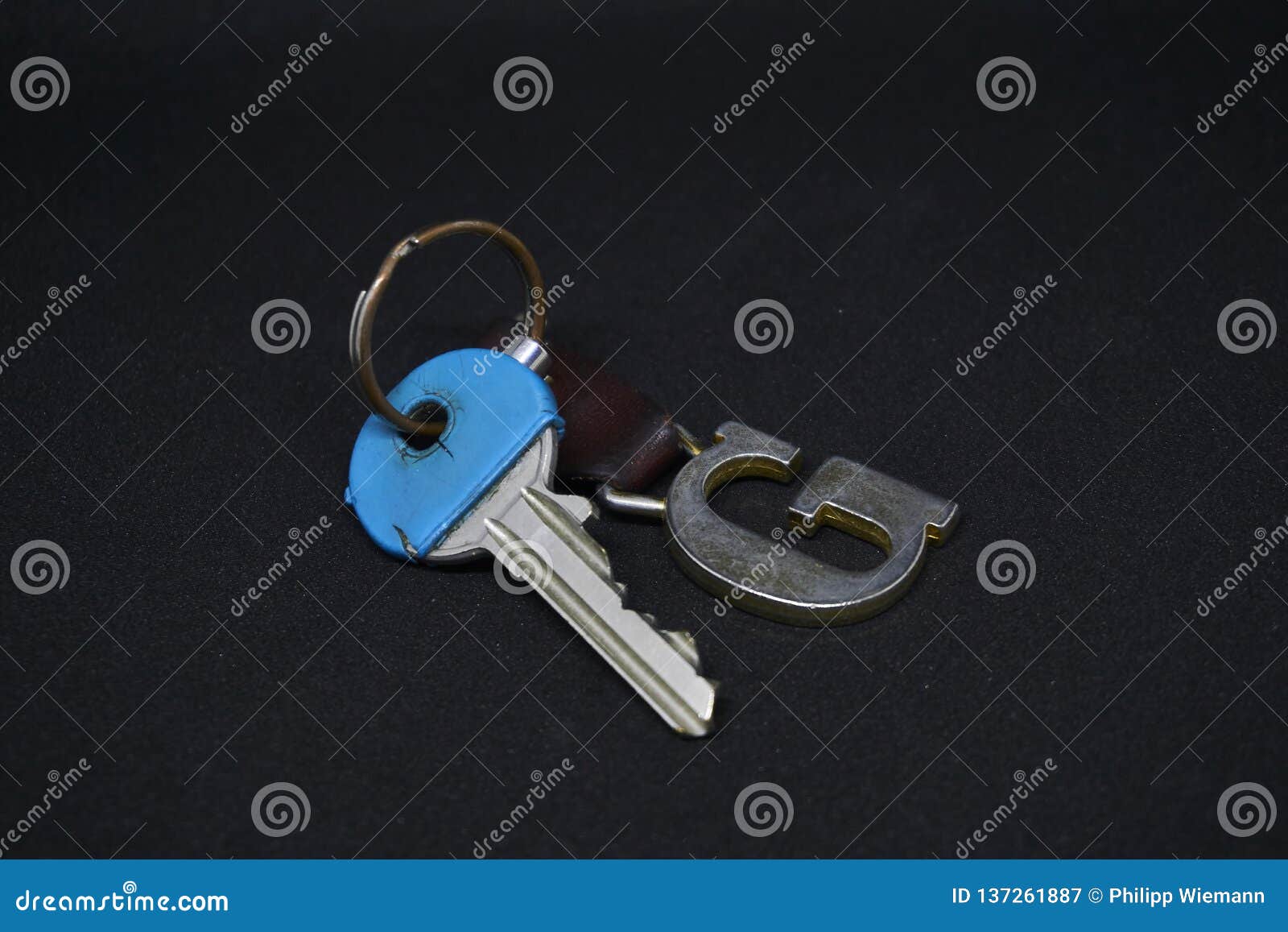 A blue key with keychains stock image. Image of business - 137261887