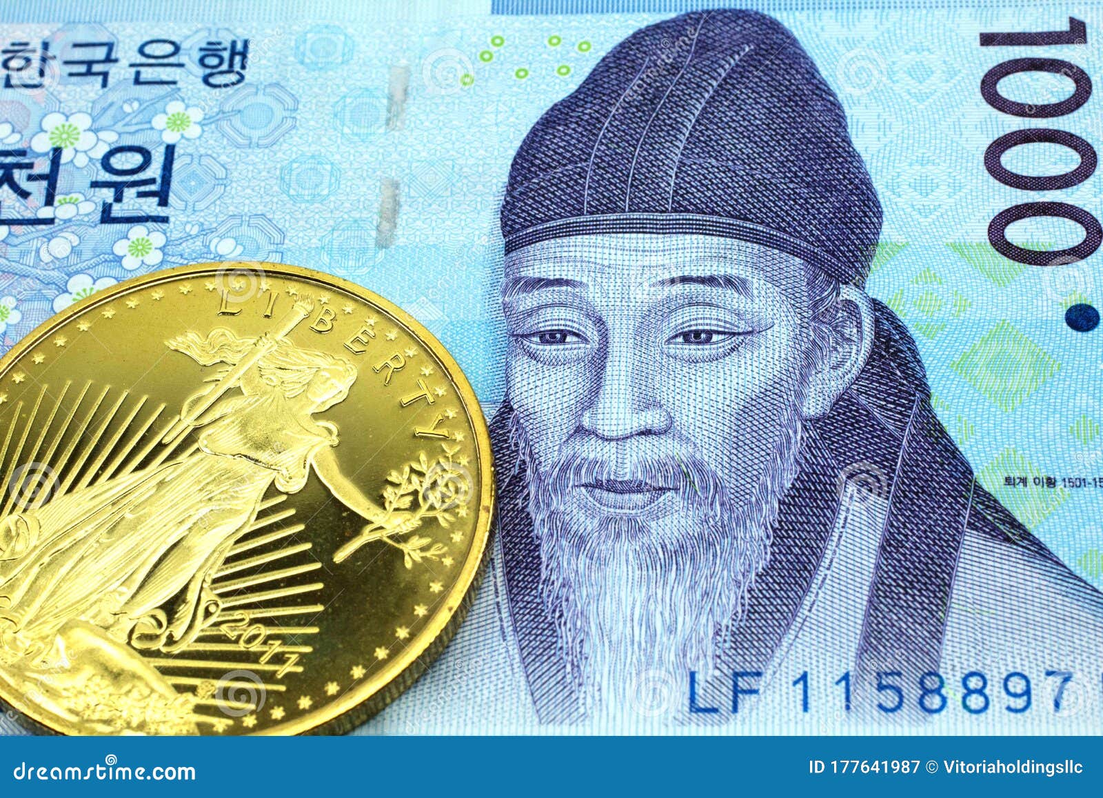 A Blue Korean 1000 Won with a Gold Coin in Macro Stock Image - Image of ...