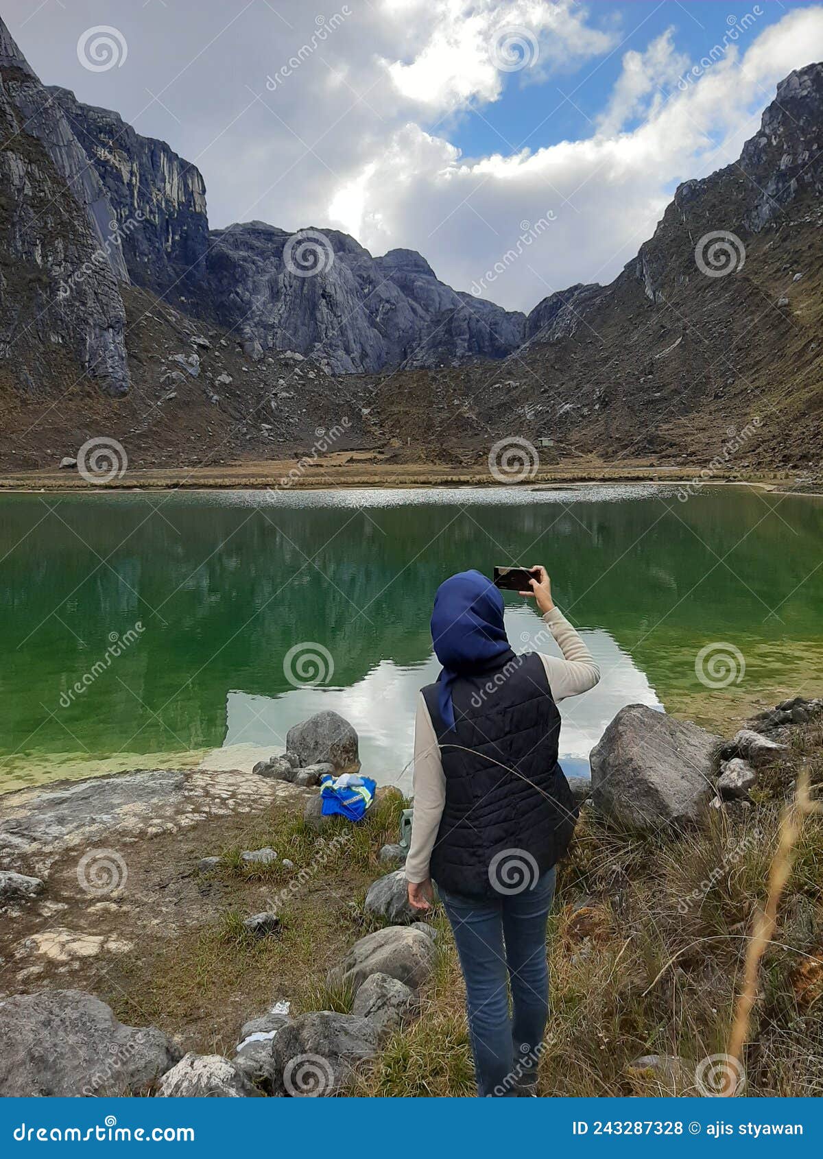 Blue lake walking stock photo. Image of jumping, walking - 243287328