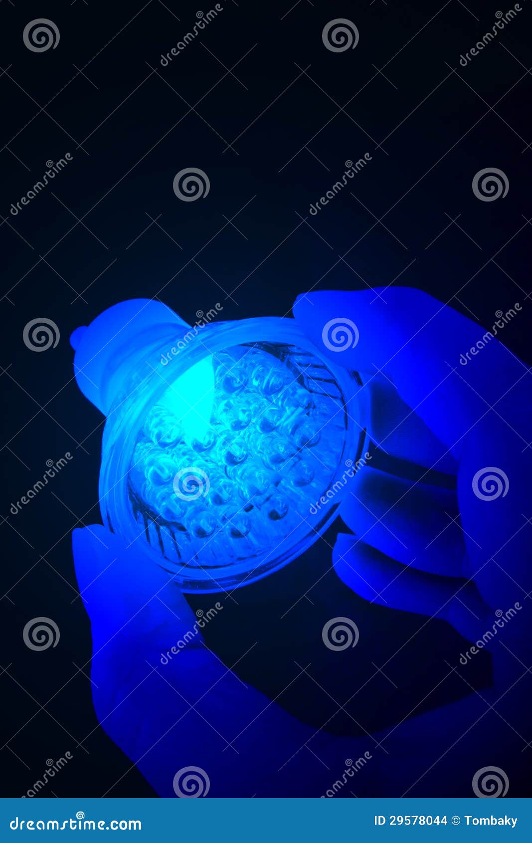 Blue led bulb in hand. stock photo. Image of modern, lamp - 29578044