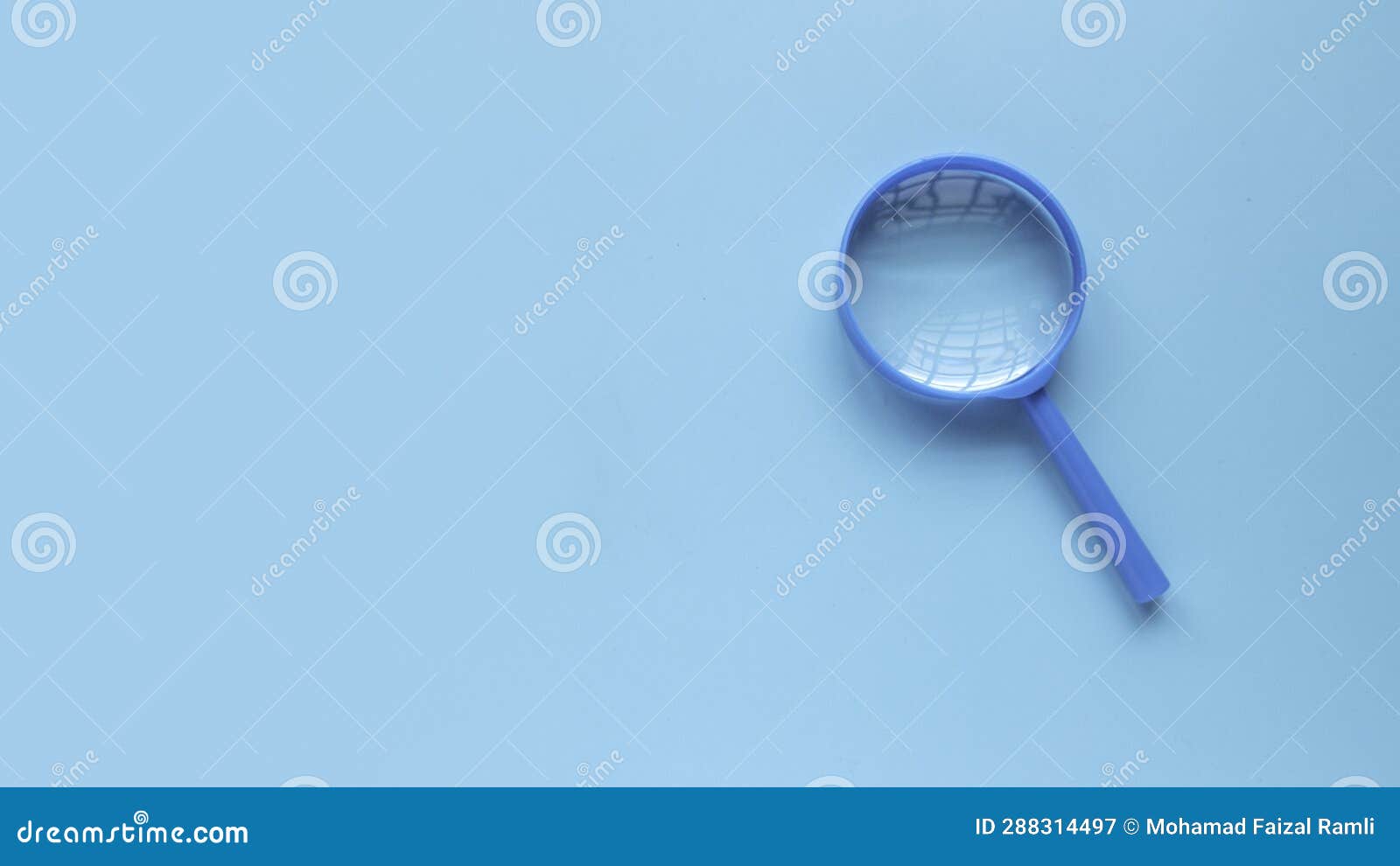 Blue Magnifying Glass Over a Blue Background. Copy Space Stock Image ...