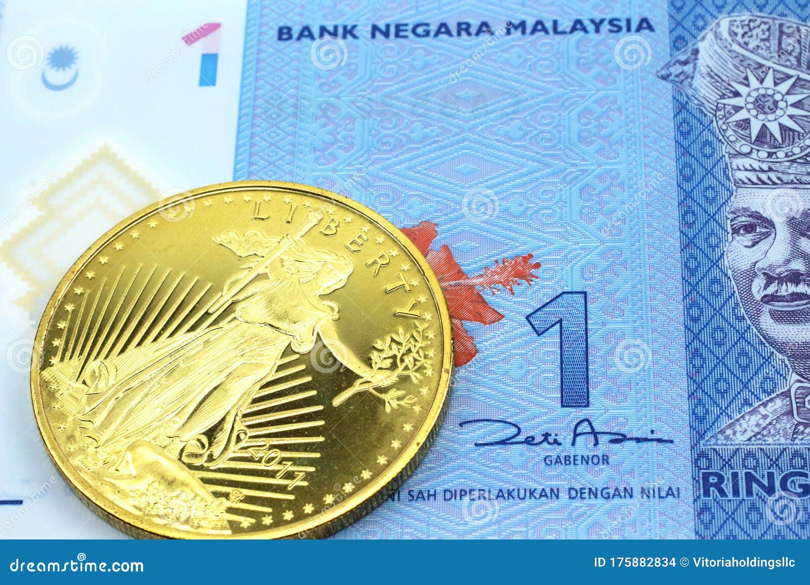 A Blue Malaysian One Ringgit Note with a Gold Coin in Macro Stock Photo ...