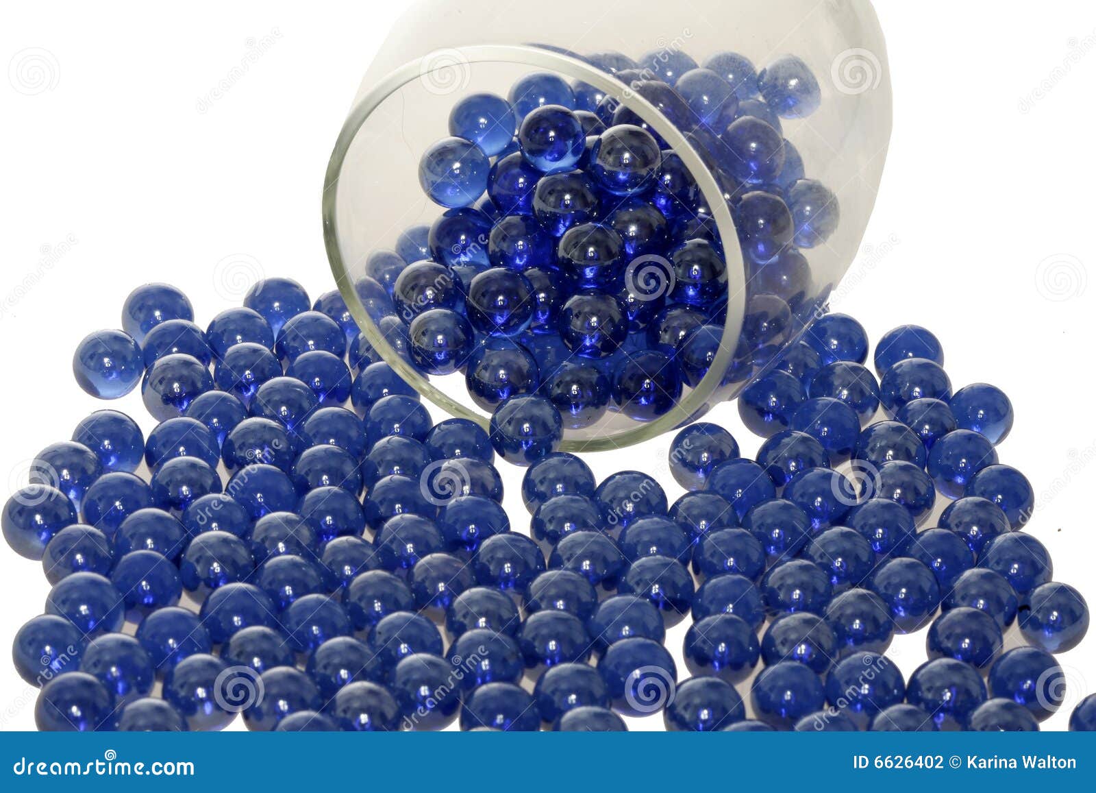 Blue Marbles Falling Out of a Glass. Stock Photo - Image of lots, drop ...
