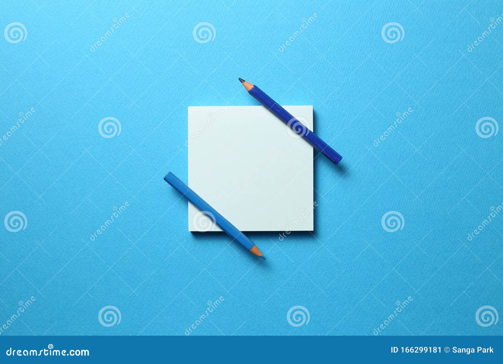 Blue Memo Note Pad and Blue Colored Pencil on Blue Background Stock ...