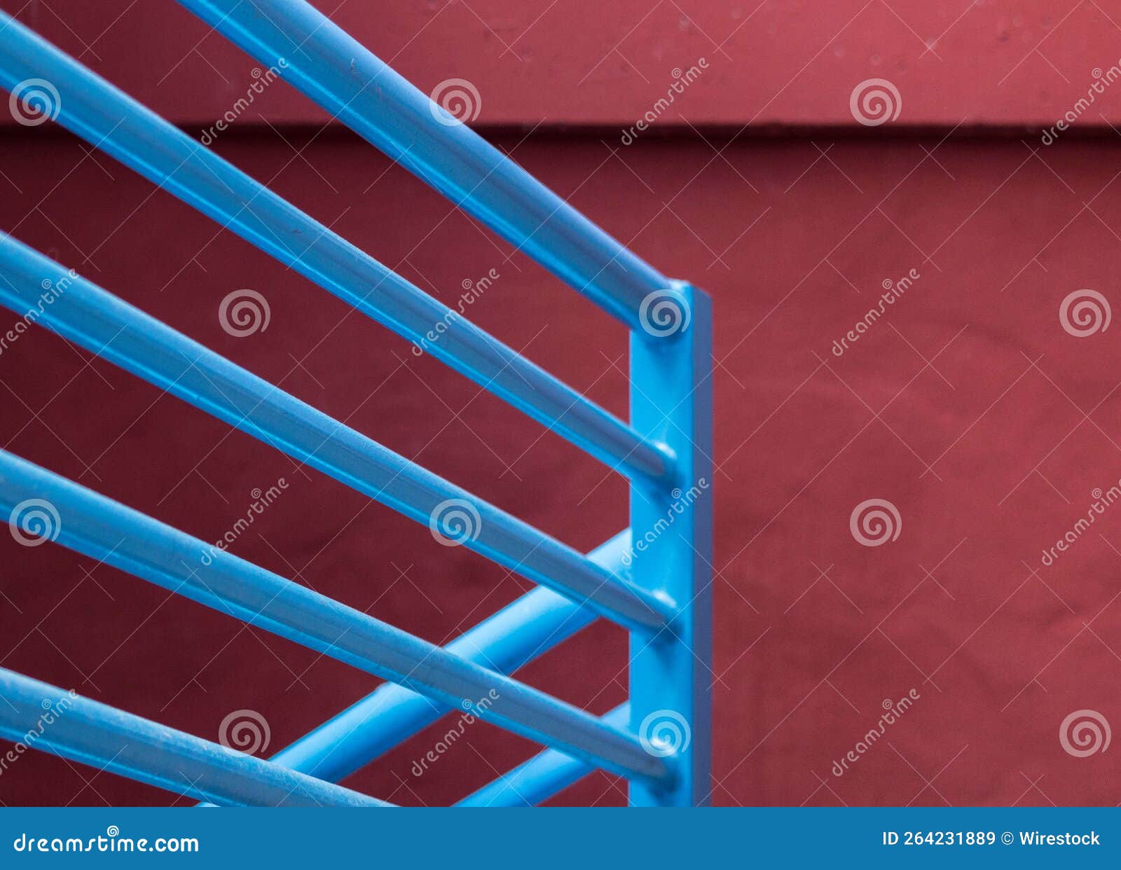 Blue Metallic Railing on the Staircase Near the Dark Red Wall Stock ...