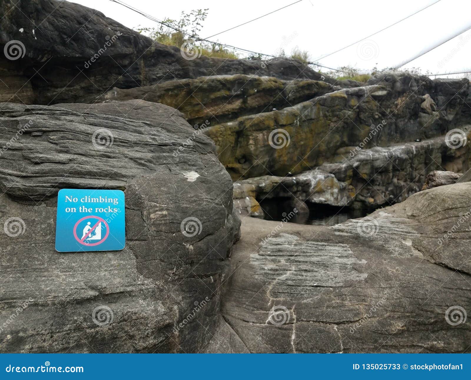 Blue No Climbing on the Rocks Sign Stock Image - Image of rocks, blue ...