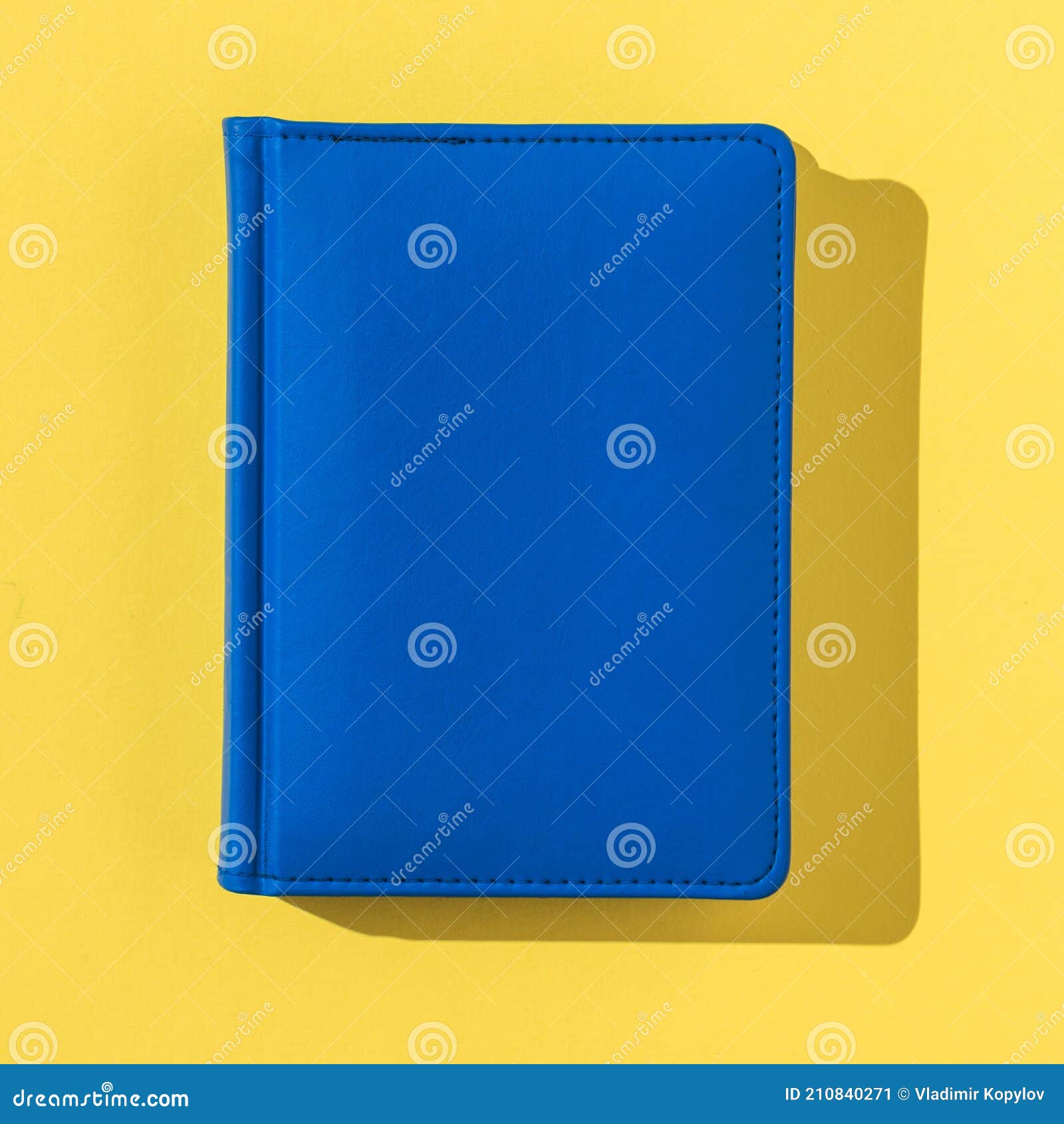 A Blue Notebook in Bright Light on a Yellow Background Stock Image ...
