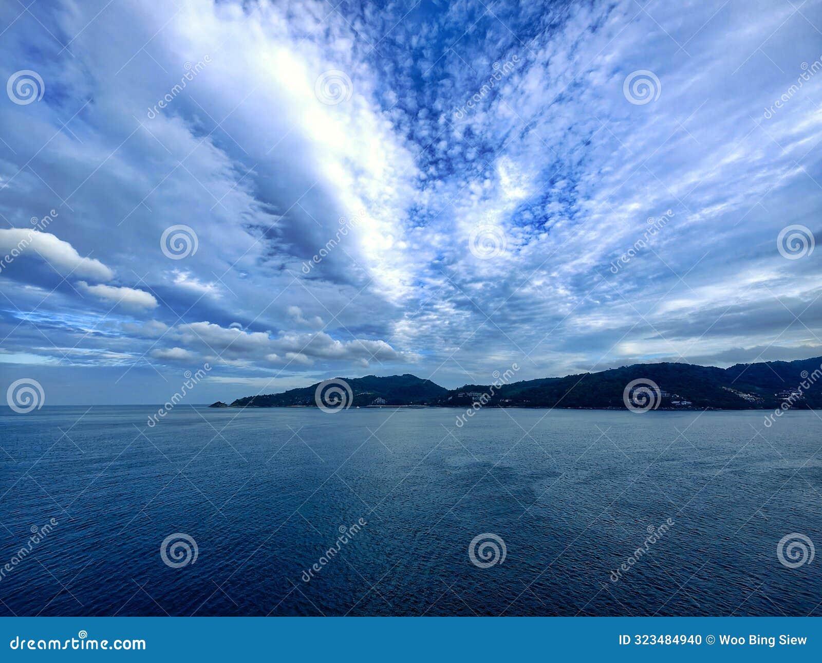 Blue Ocean and Mountains with Clouds Stock Photo - Image of shore ...