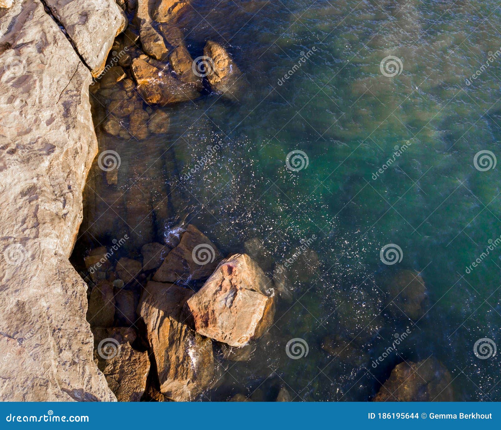 Blue ocean with rocks stock photo. Image of autumn, wall - 186195644