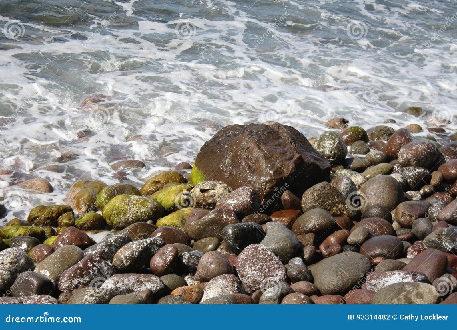 Blue Ocean and a Shoreline Filled with Rocks Stock Photo - Image of ...