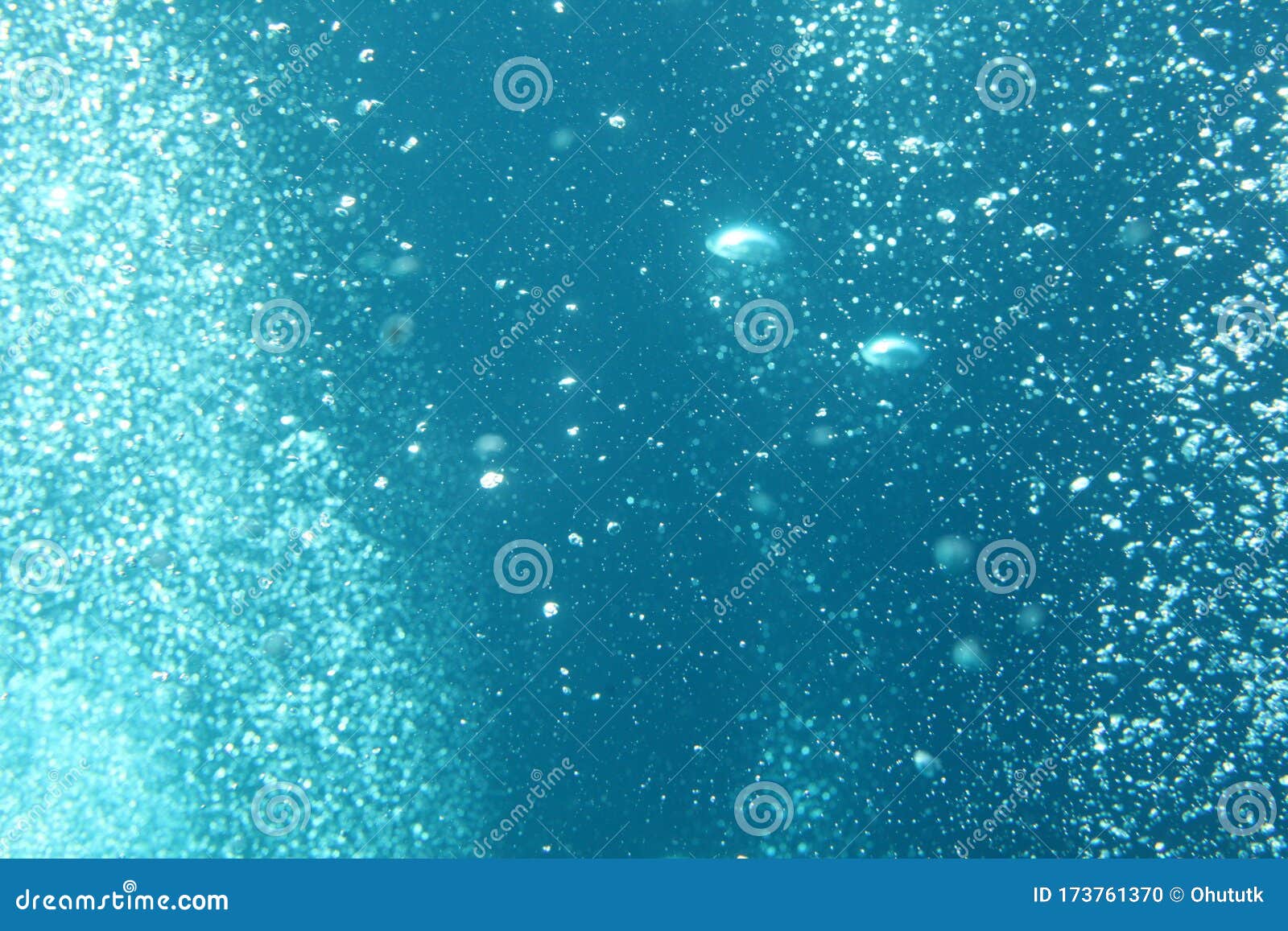 Blue Ocean Waves from Underwater with Bubbles. Light Rays Shining ...