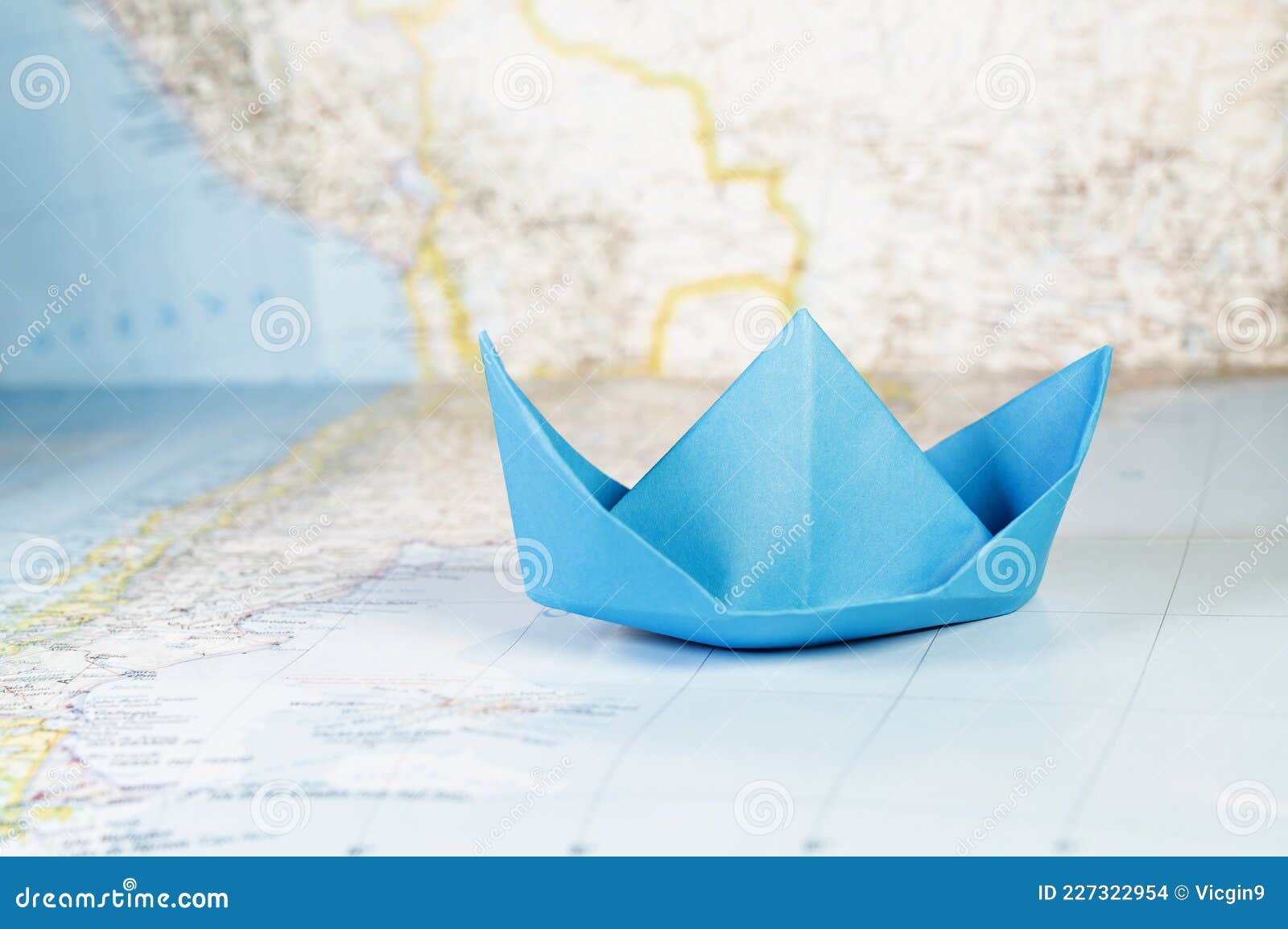 Blue paper boat on map stock photo. Image of leisure - 227322954