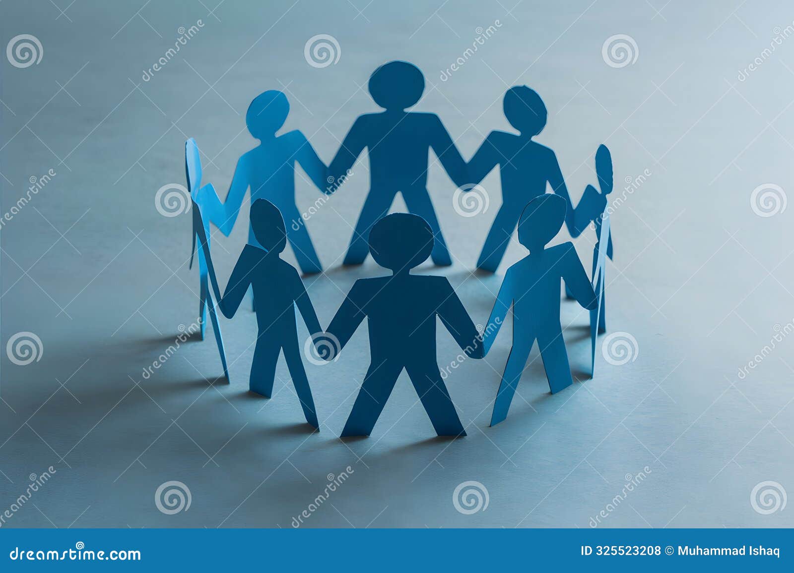 Blue Paper Cut Outs of Human Figures on a Light Blue Backdrop Stock ...