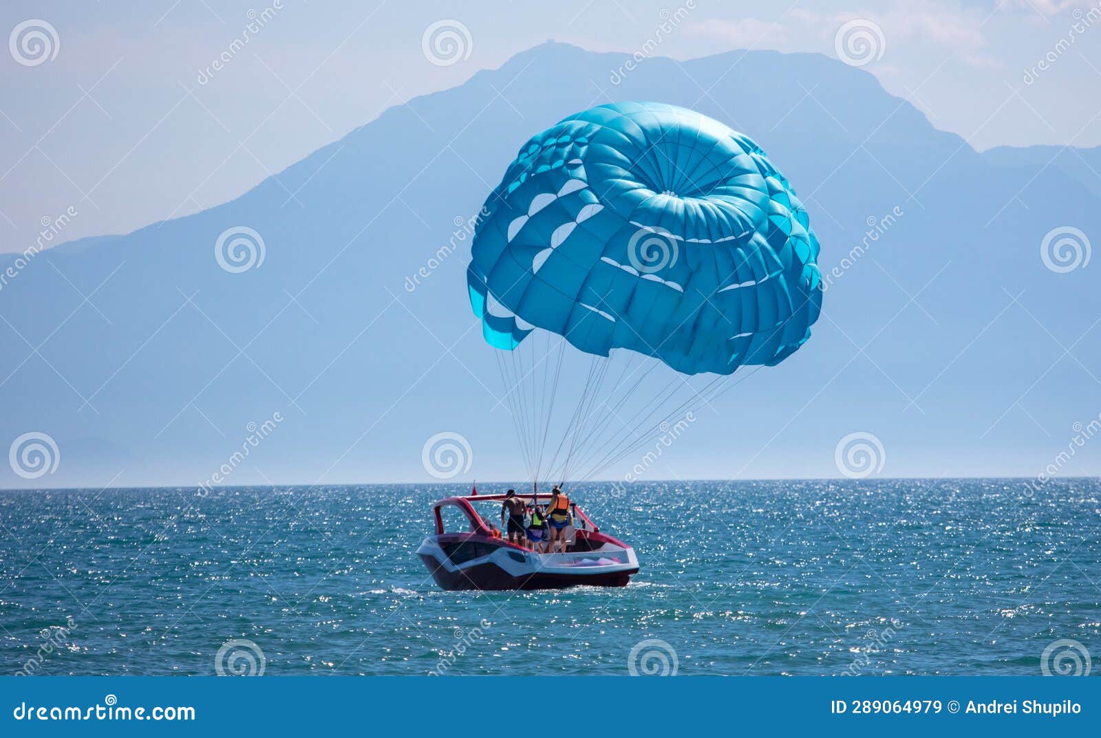 A Blue Parachute Flies Over the Sea Stock Image - Image of sport ...