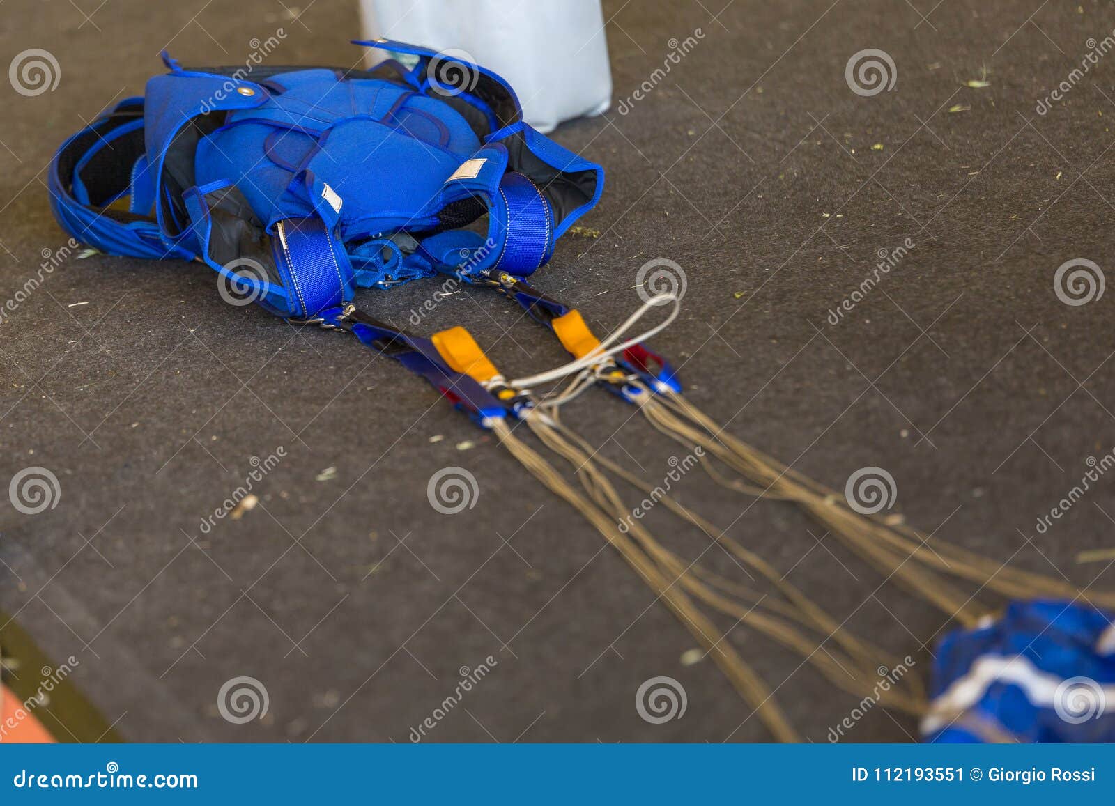 Blue Parachute Folded Up on the Ground Stock Image - Image of parachute ...