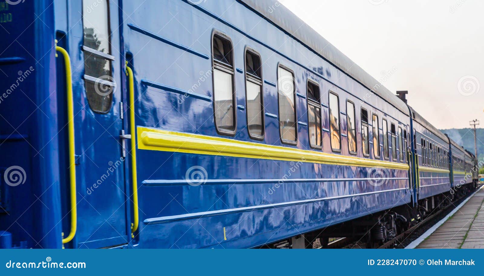 A Blue Passenger Train Travels Along Stock Photo - Image of departure ...