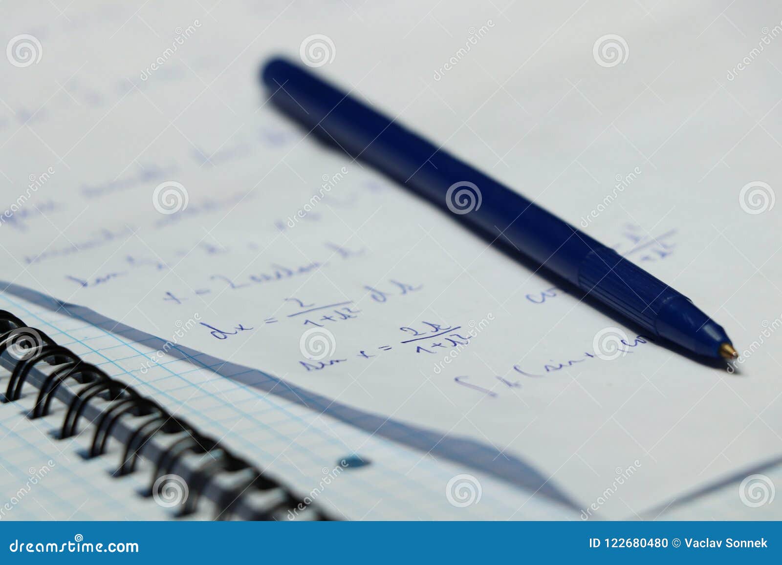 A Blue Pen with Small Exercise Book and Different Make a Calculation in ...