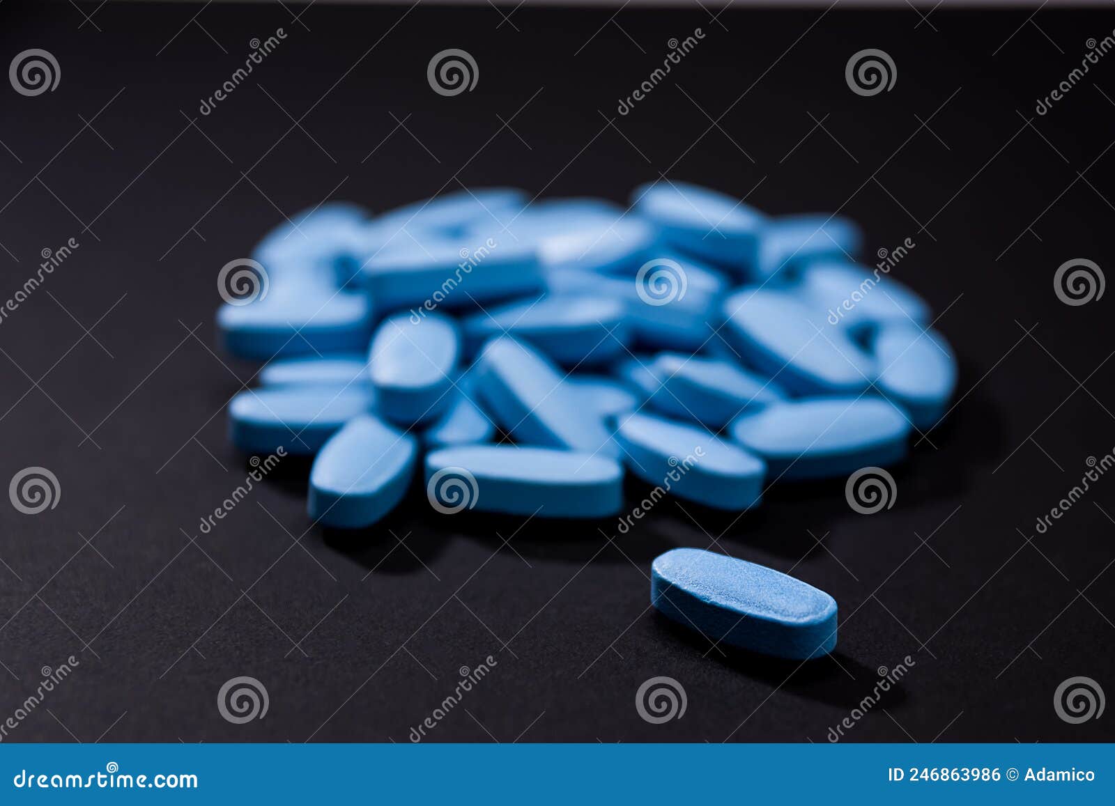 Blue Pill in the Foreground and Blurry Background Heap of Blue Colored ...