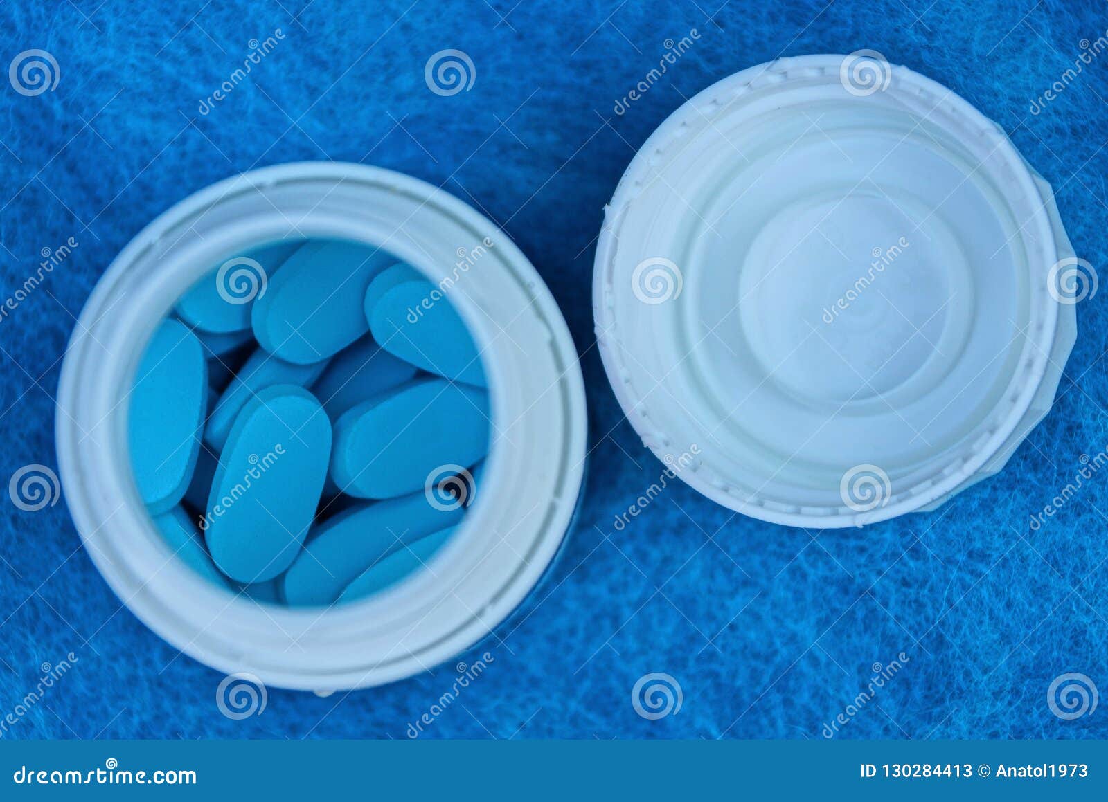 Blue Pills in a White Bottle and a Cap on Wool Stock Image - Image of ...