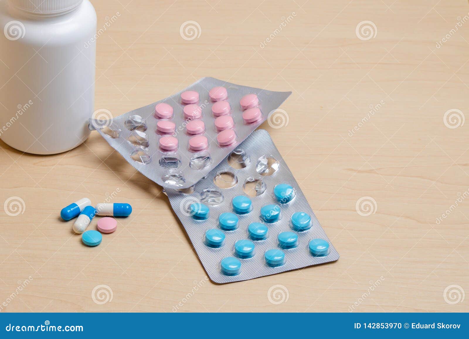 Blue and Pink Pills in the Package on the Table. Close-up Stock Photo ...