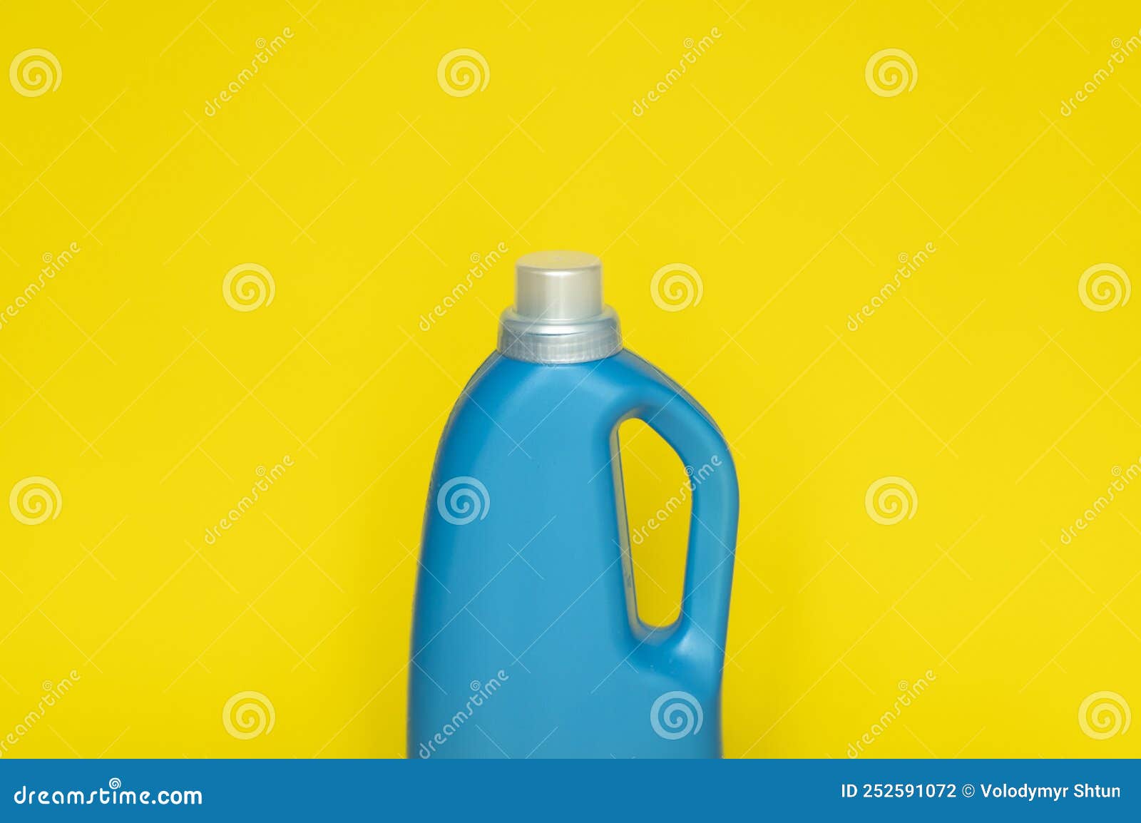 Blue Plastic Bottle with a Grey Cap Isolated on Yellow Background for ...