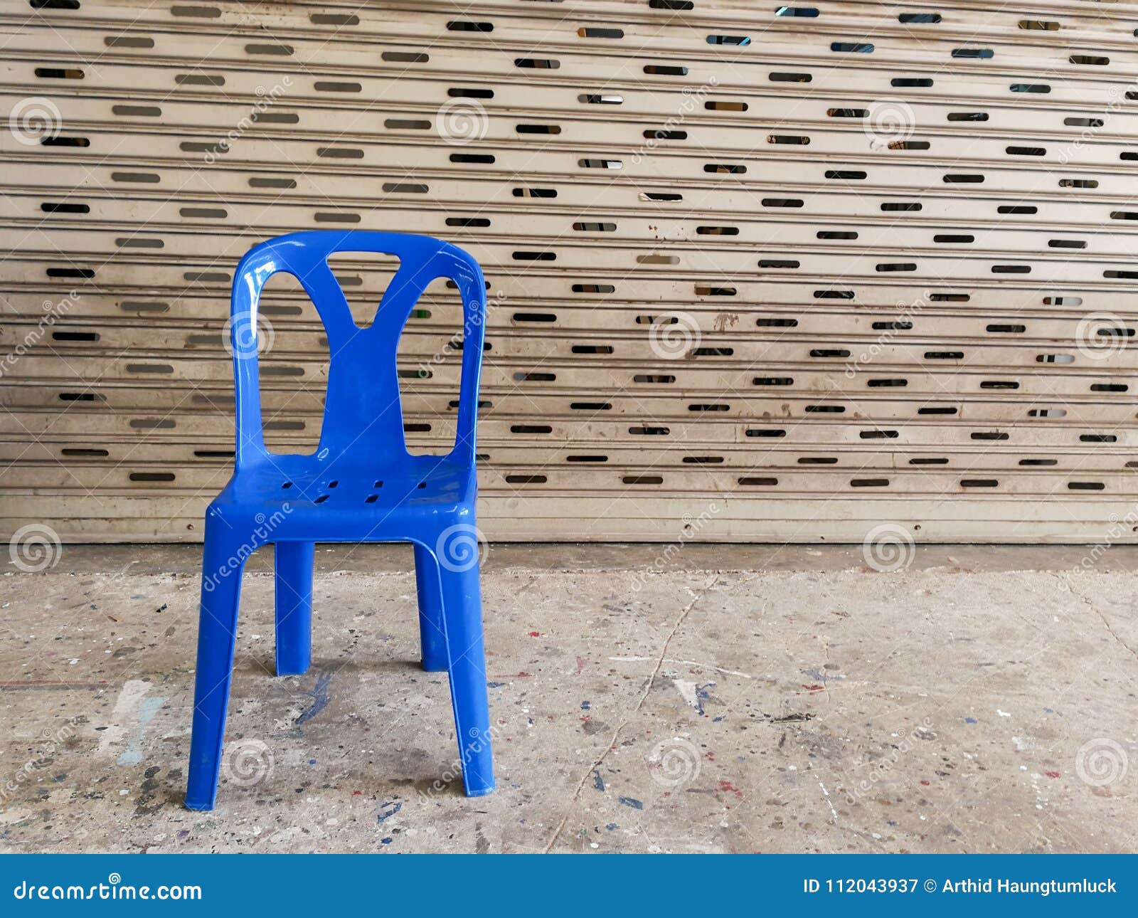 Blue Plastic Chair on Cobbled Pavement Stock Image - Image of floor ...