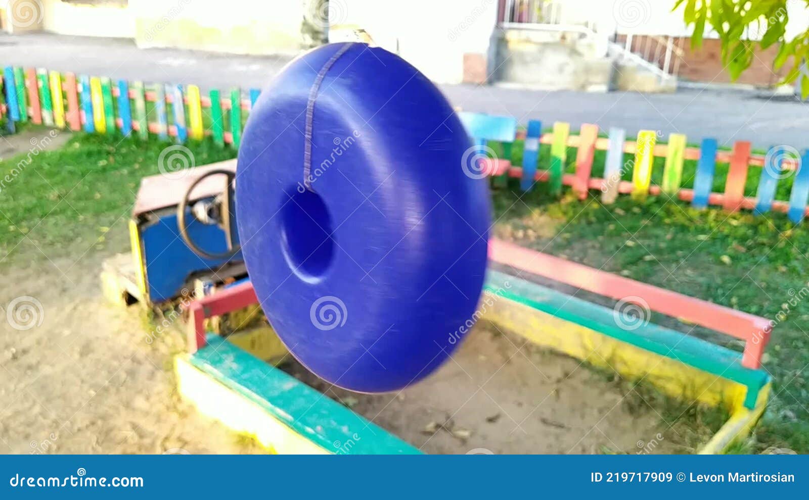 Blue Plastic Circle Suspended from a Tree from a Rope Swings from Side ...