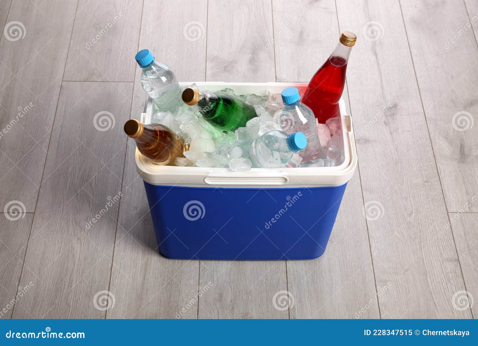 Blue Plastic Cool Box with Ice Cubes and Refreshing Drinks on Wooden ...