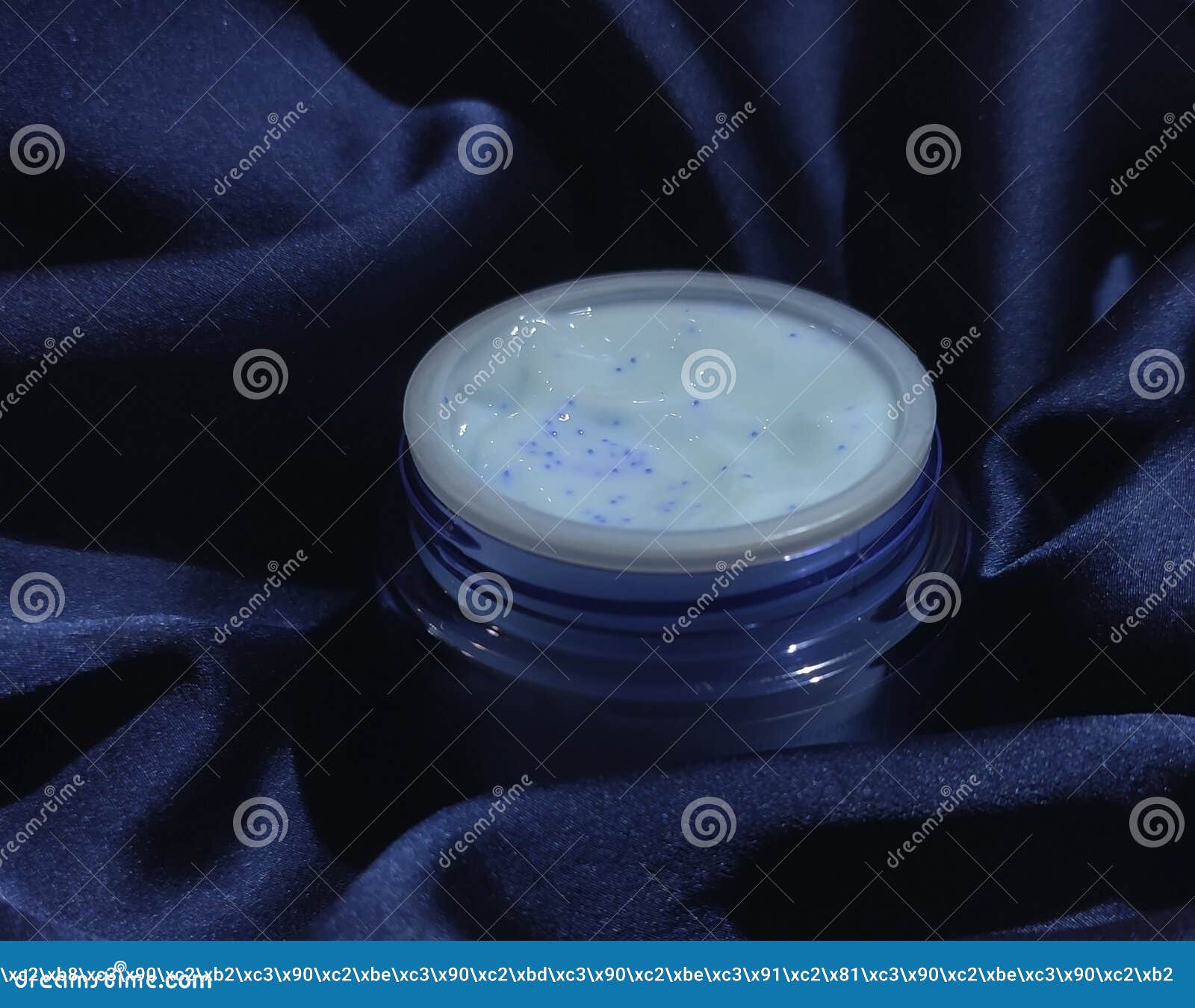 Blue Plastic Cosmetic Jar with Cream on Satin Fabric Stock Photo ...
