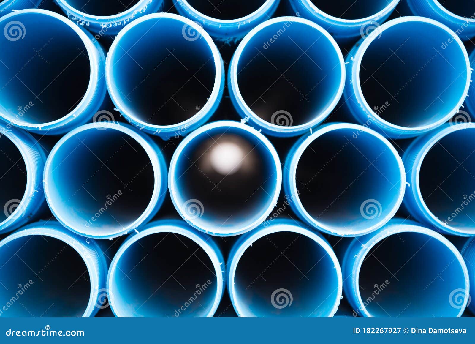 Blue Plastic Pipes Stacked in Rows. Look Inside the Pipe. Background ...