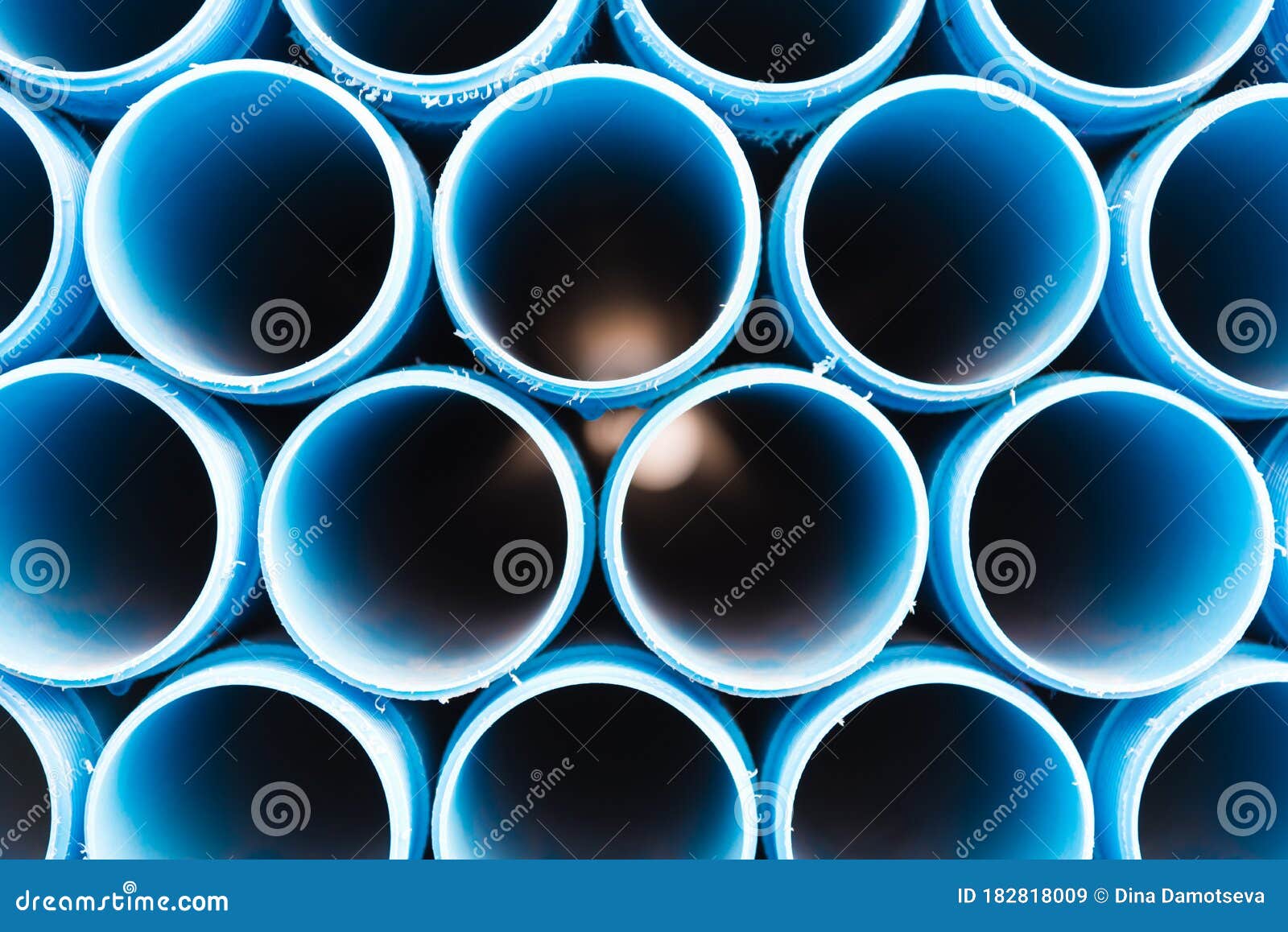 Blue Plastic Pipes Stacked in Rows. Look Inside the Pipe. Background ...