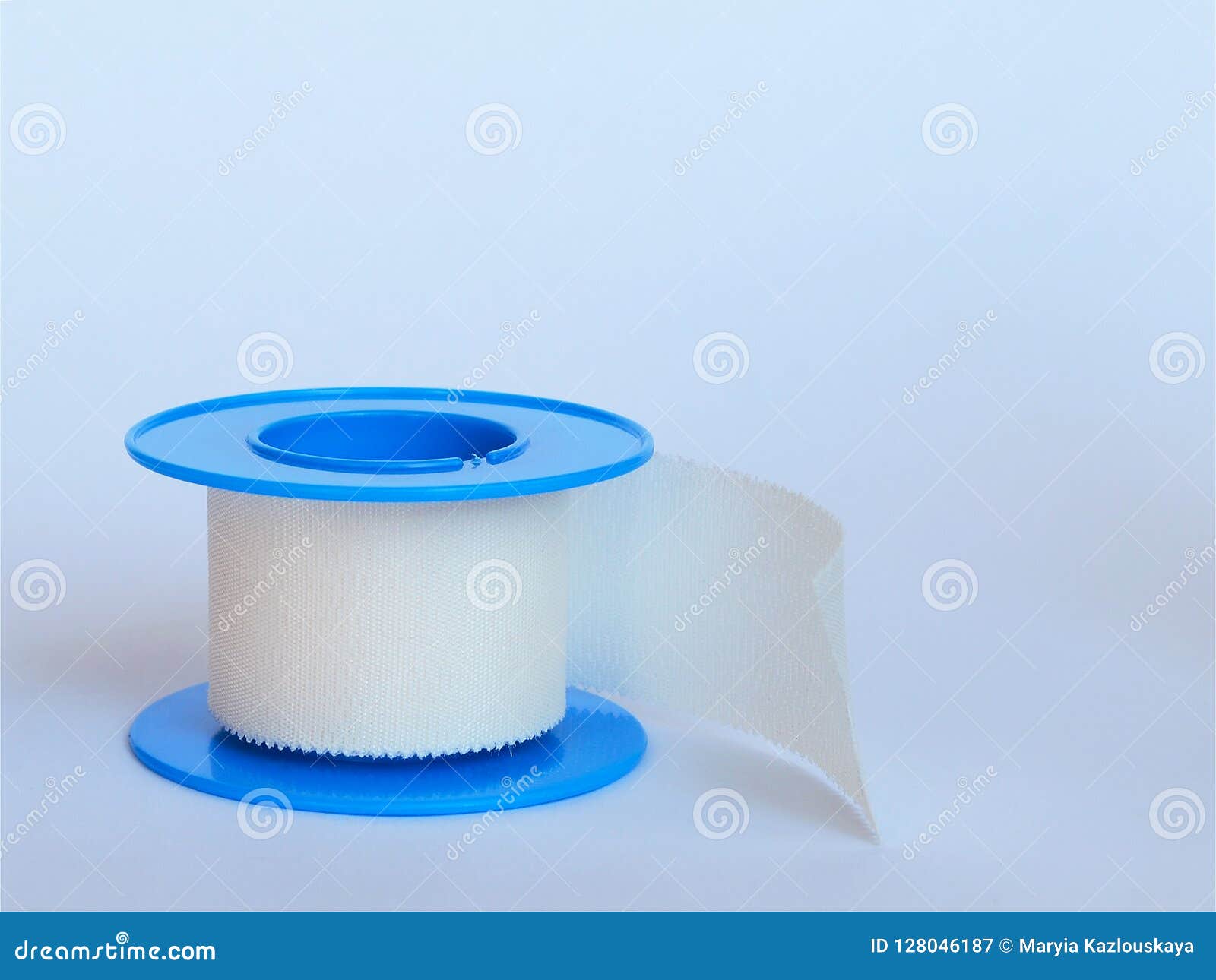 Blue Plastic Roll with White Textile Medical Plaster on a Neutral ...