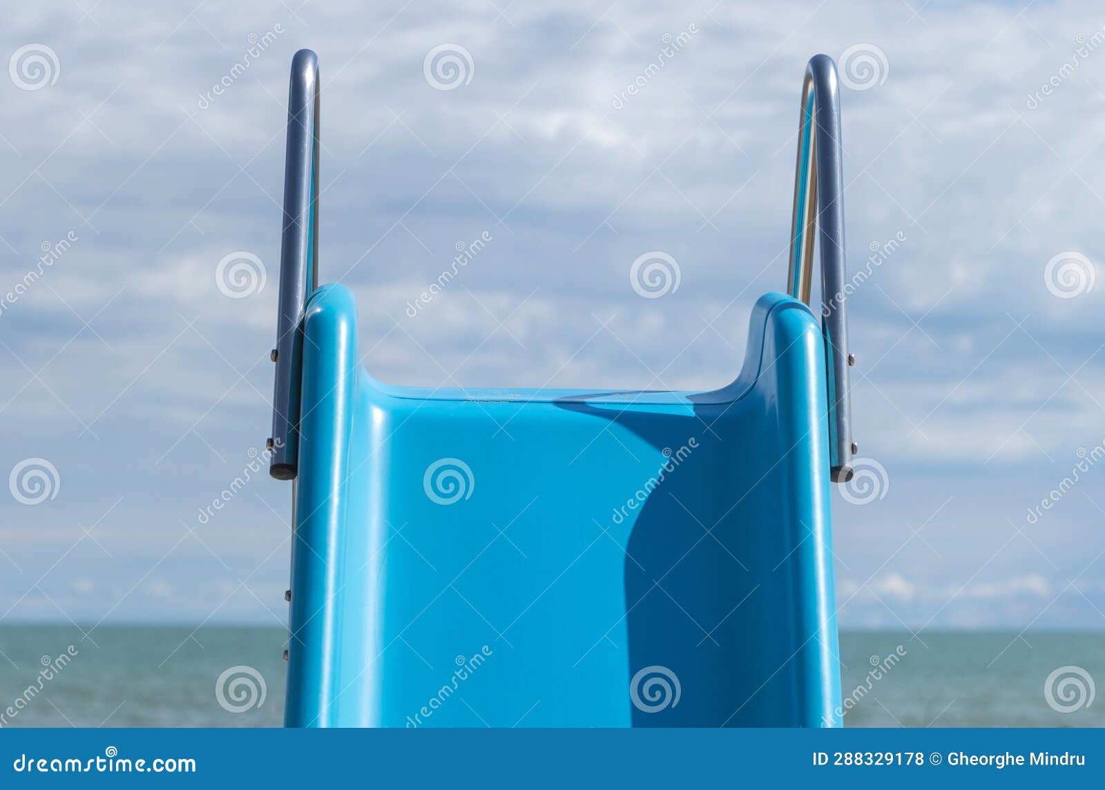 Blue Plastic Slide on the Beach, Blue Sky and White Clouds Background ...