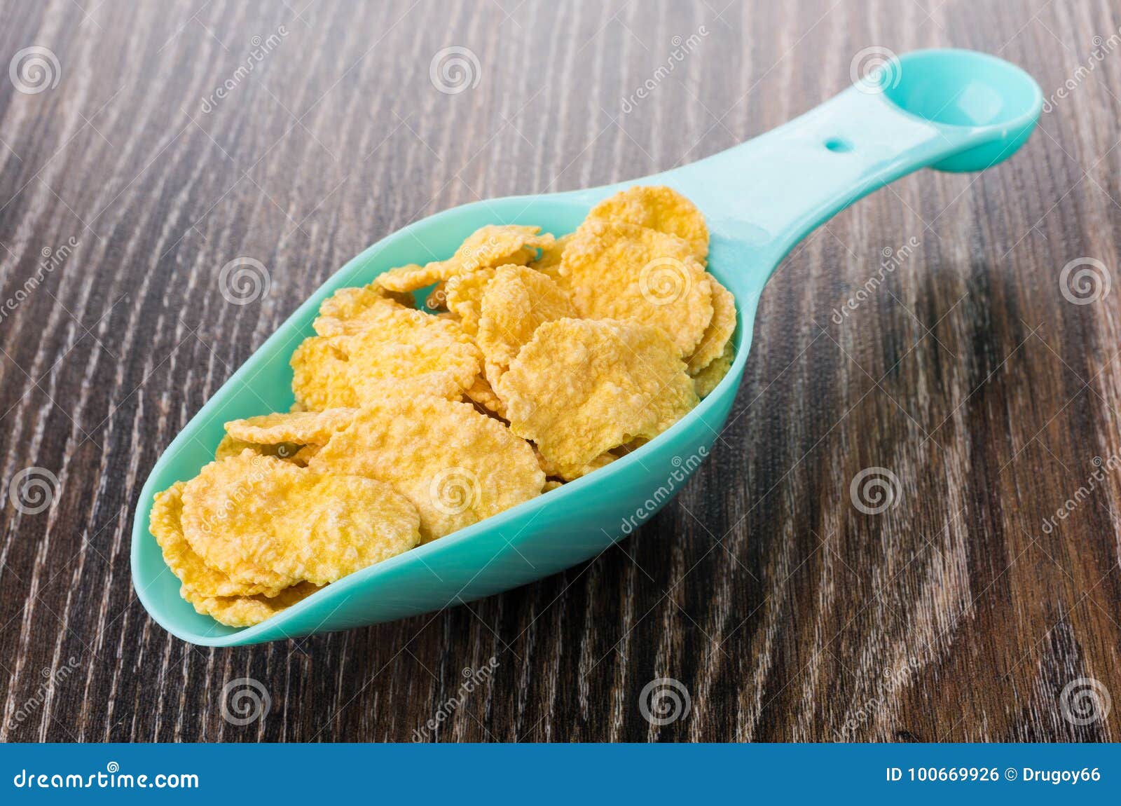 Blue Plastic Spoon with Corn Flakes on Wooden Table Stock Photo - Image ...