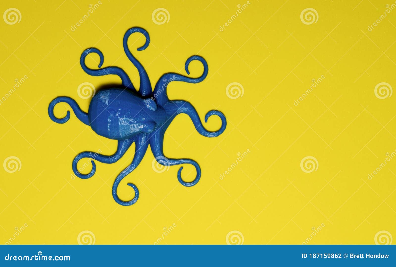 Blue Plastic Toy Octopus on Plain Yellow Background. Stock Photo ...