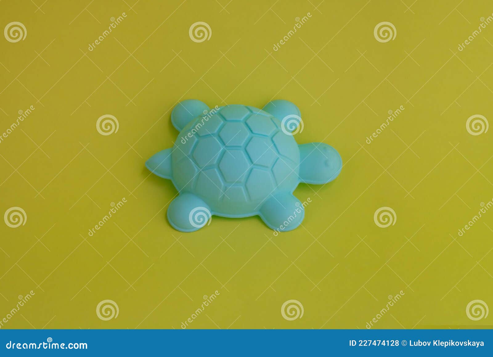 A Blue Plastic Turtle Toy, Isolated On A Yellow Background Royalty-Free ...